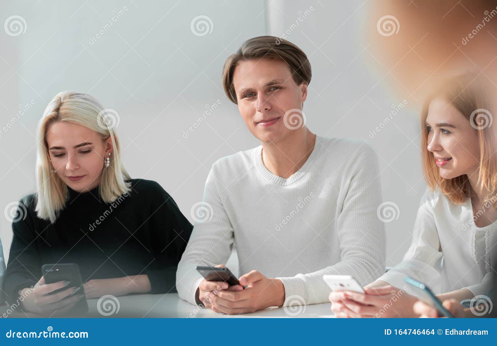 Group of Young People Sitting at a Round Table Stock Photo - Image of ...