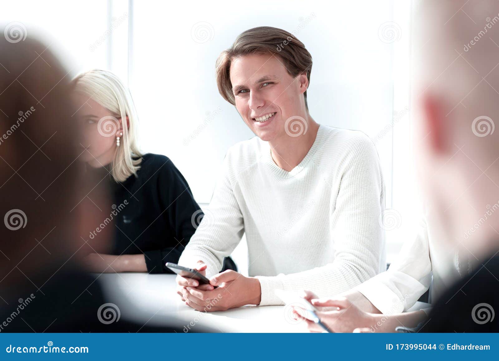 Group of Young People Sitting at a Round Table Stock Photo - Image of ...