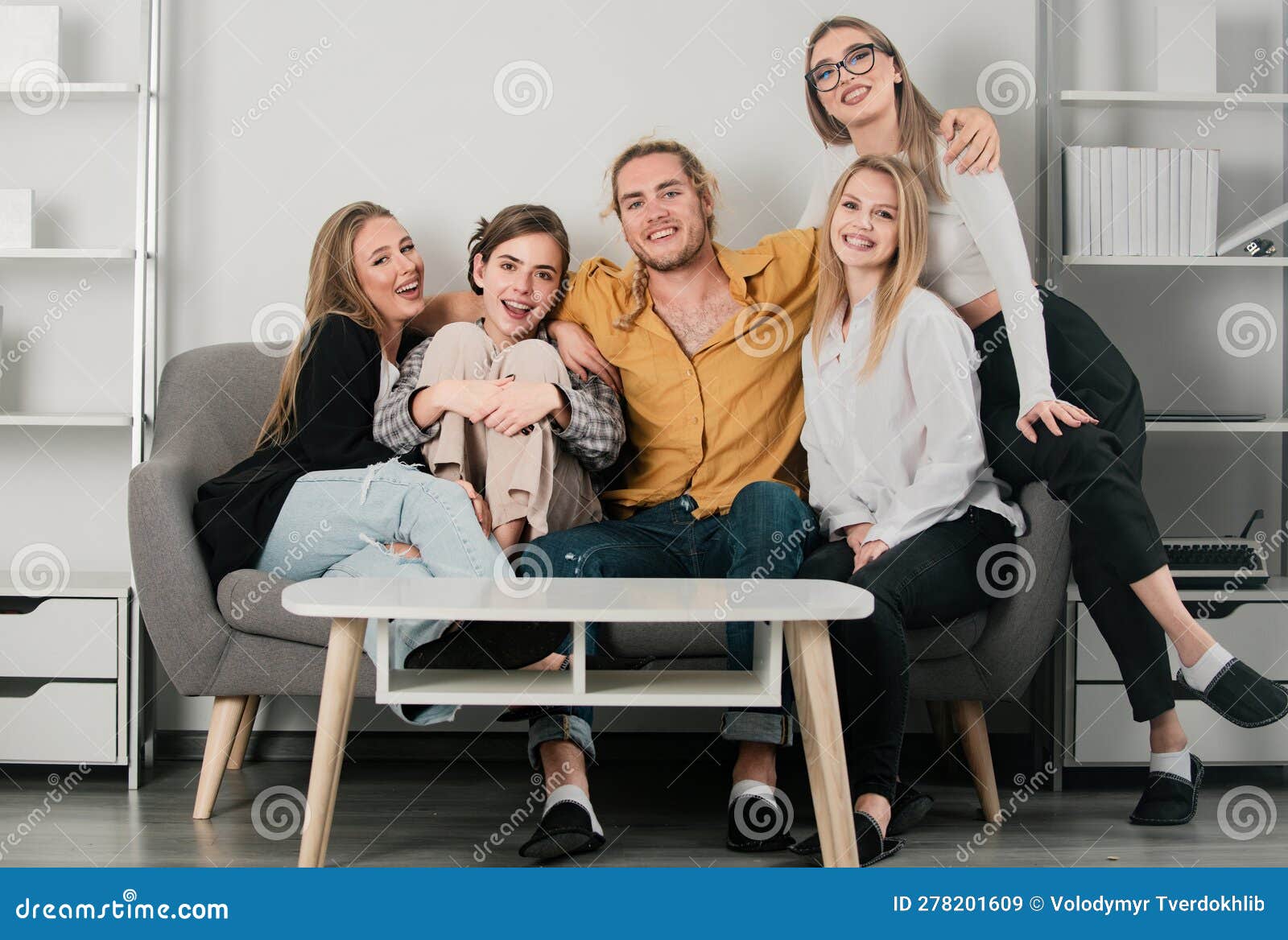 Group of Young People Sitting on Sofa and Talking at Home. Students ...