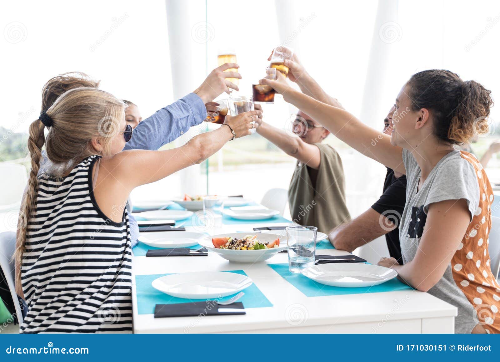 Group of Young People Sitting at a White Table with Empty Plates ...