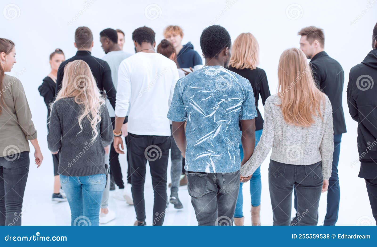 A Group of Young People Stand with Their Backs Looking into the Stock ...