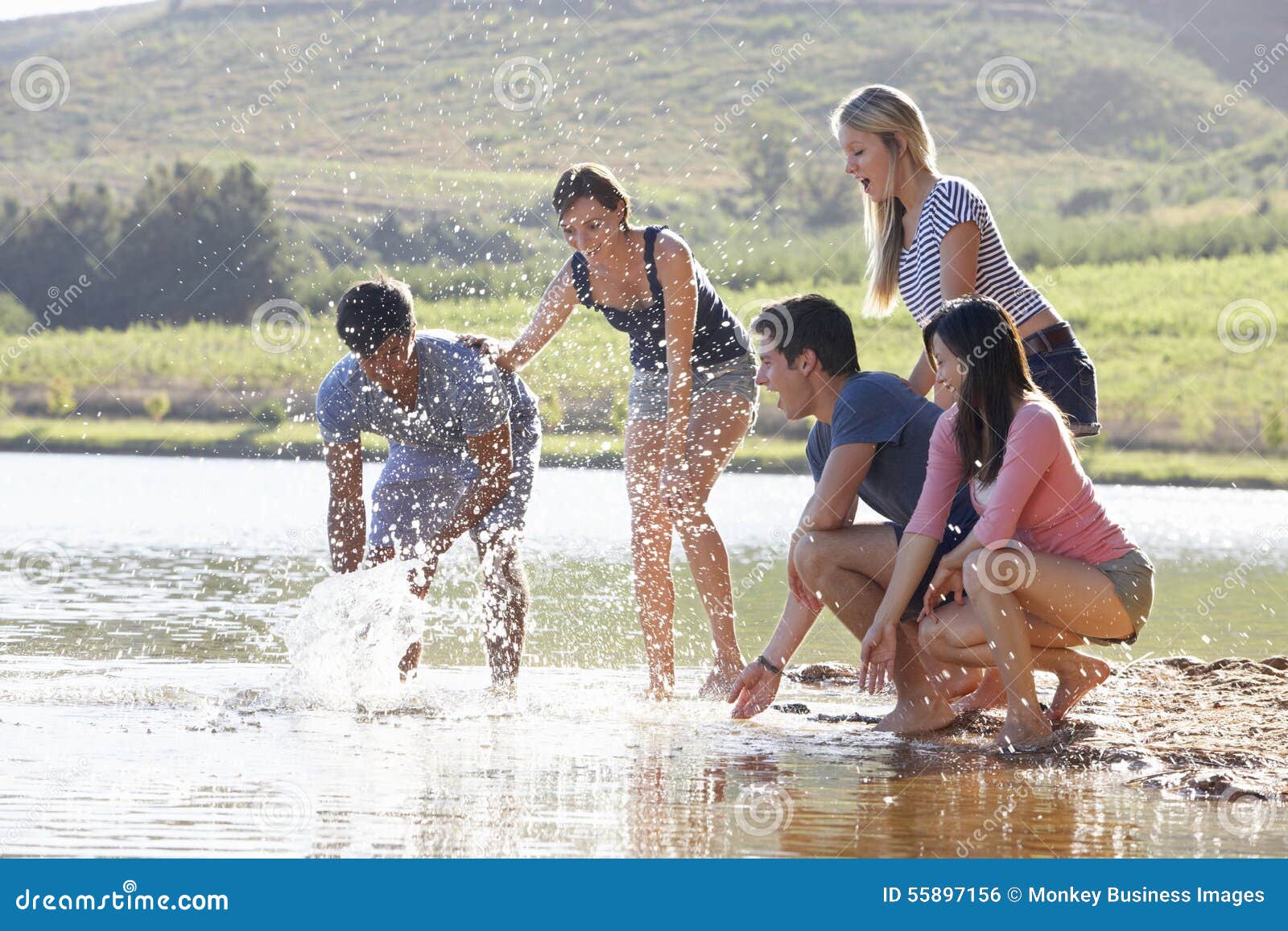 Group of Young People Standing at Shore of Lake Stock Photo - Image of ...
