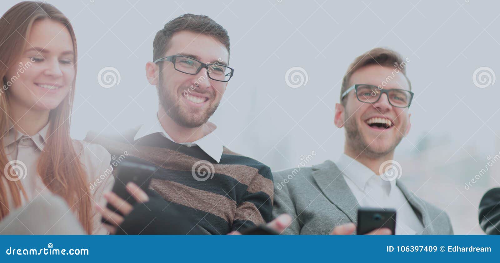 A Group of Young and Happy Young People Using Their Phones and C Stock ...