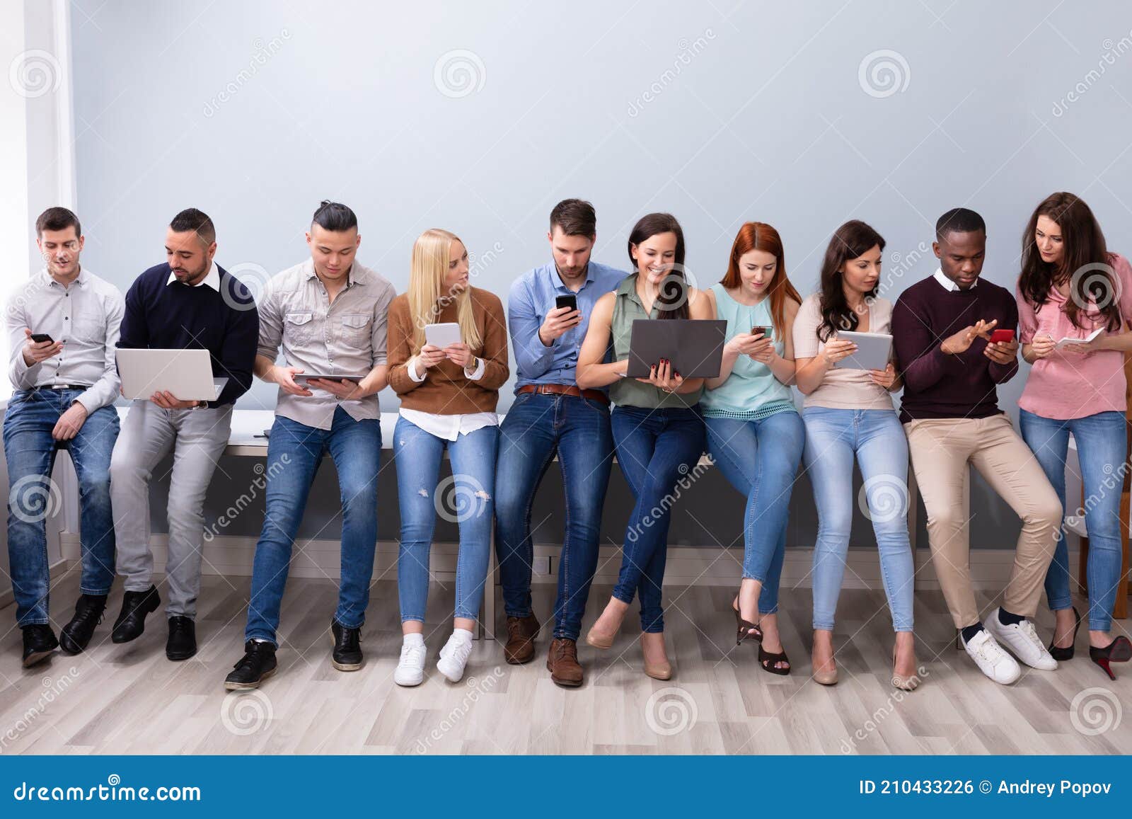 Group of Young People Using Various Electronic Gadgets Stock Photo ...