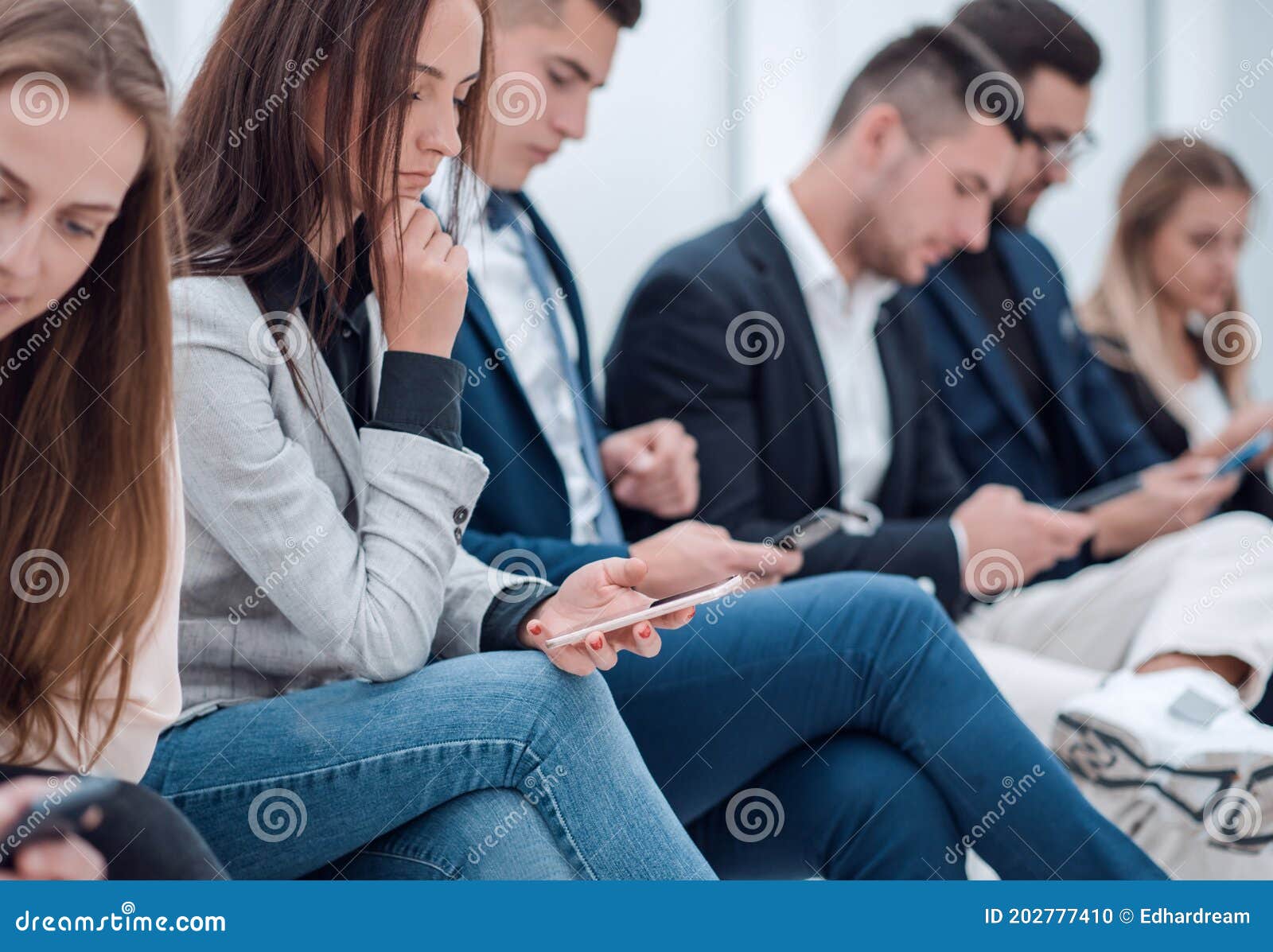 Group of Young People Waiting, Sitting in the Queue Stock Photo - Image ...