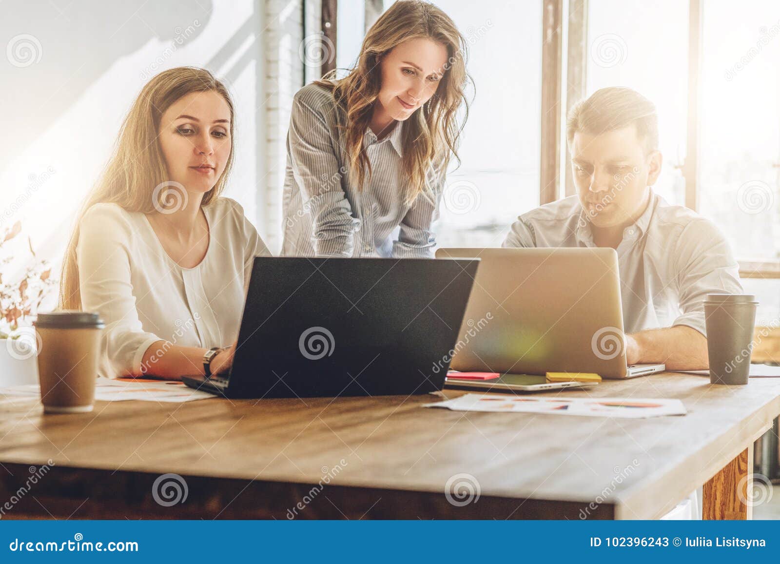 Group of Young People Work Together.People Work on Laptops,discuss ...
