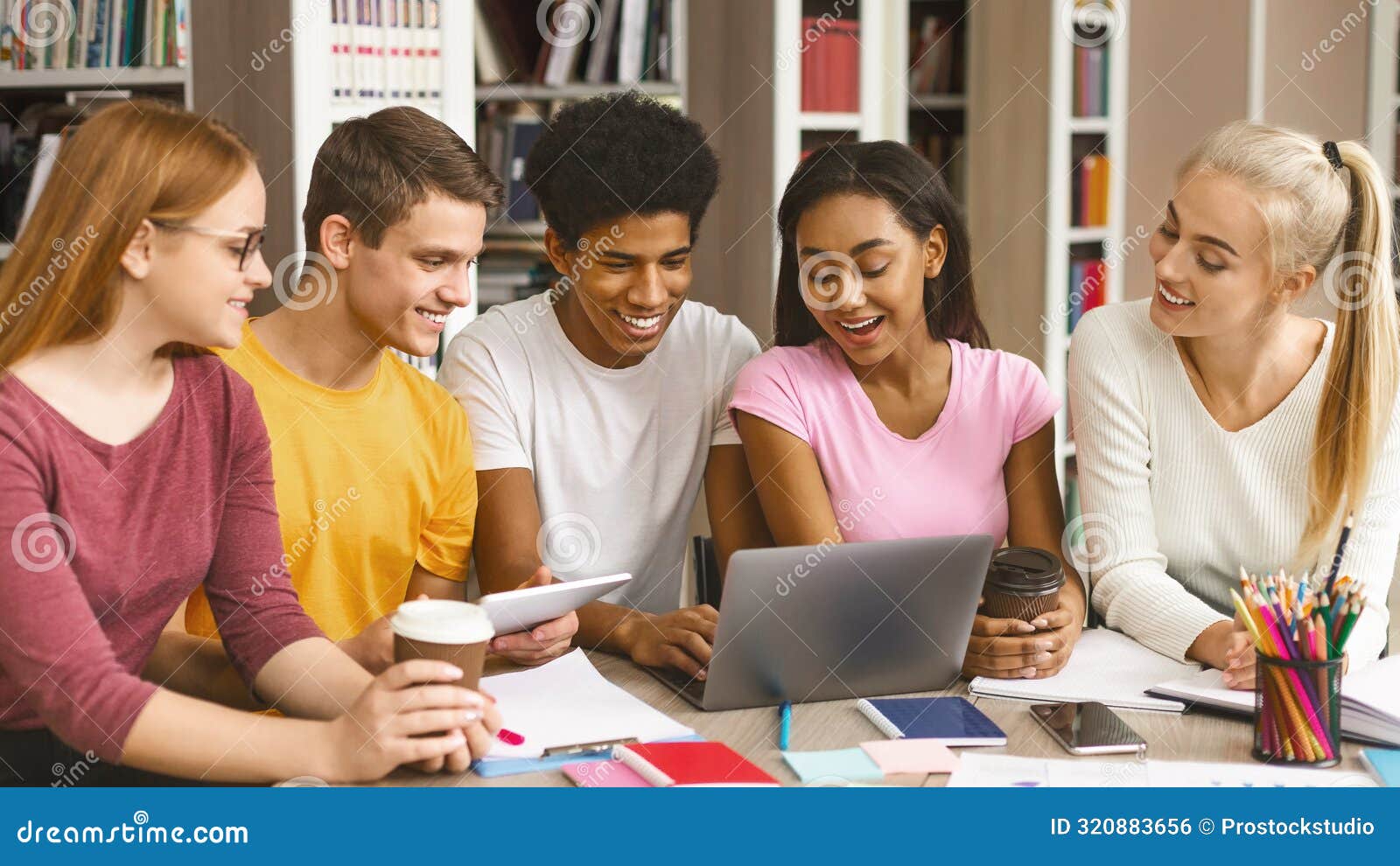 Group of Young People Working with Laptop in Library Stock Photo ...