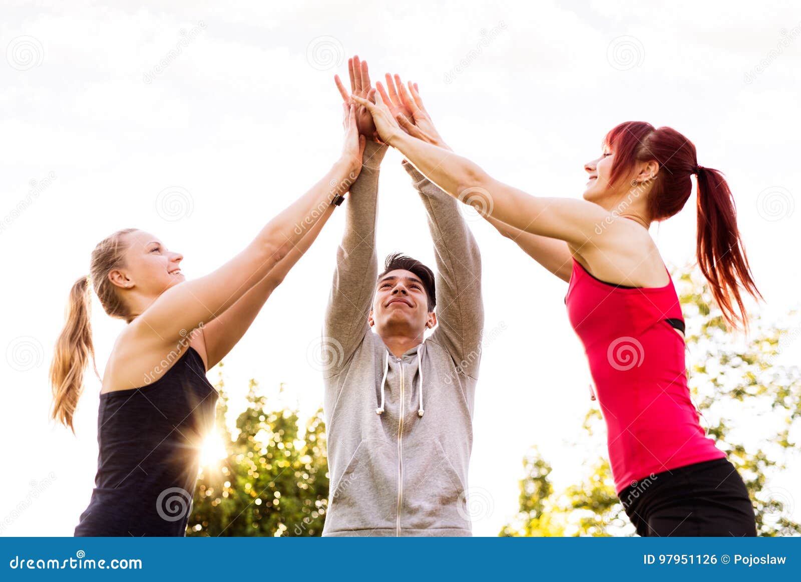 Group of Young Runners in Park Doing High Five Gesture. Stock Photo ...