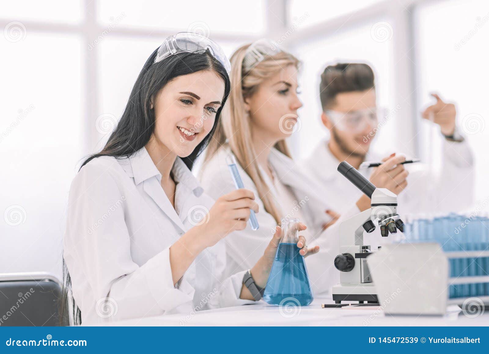 Group of Young Scientists Conduct Research in the Laboratory . Stock ...