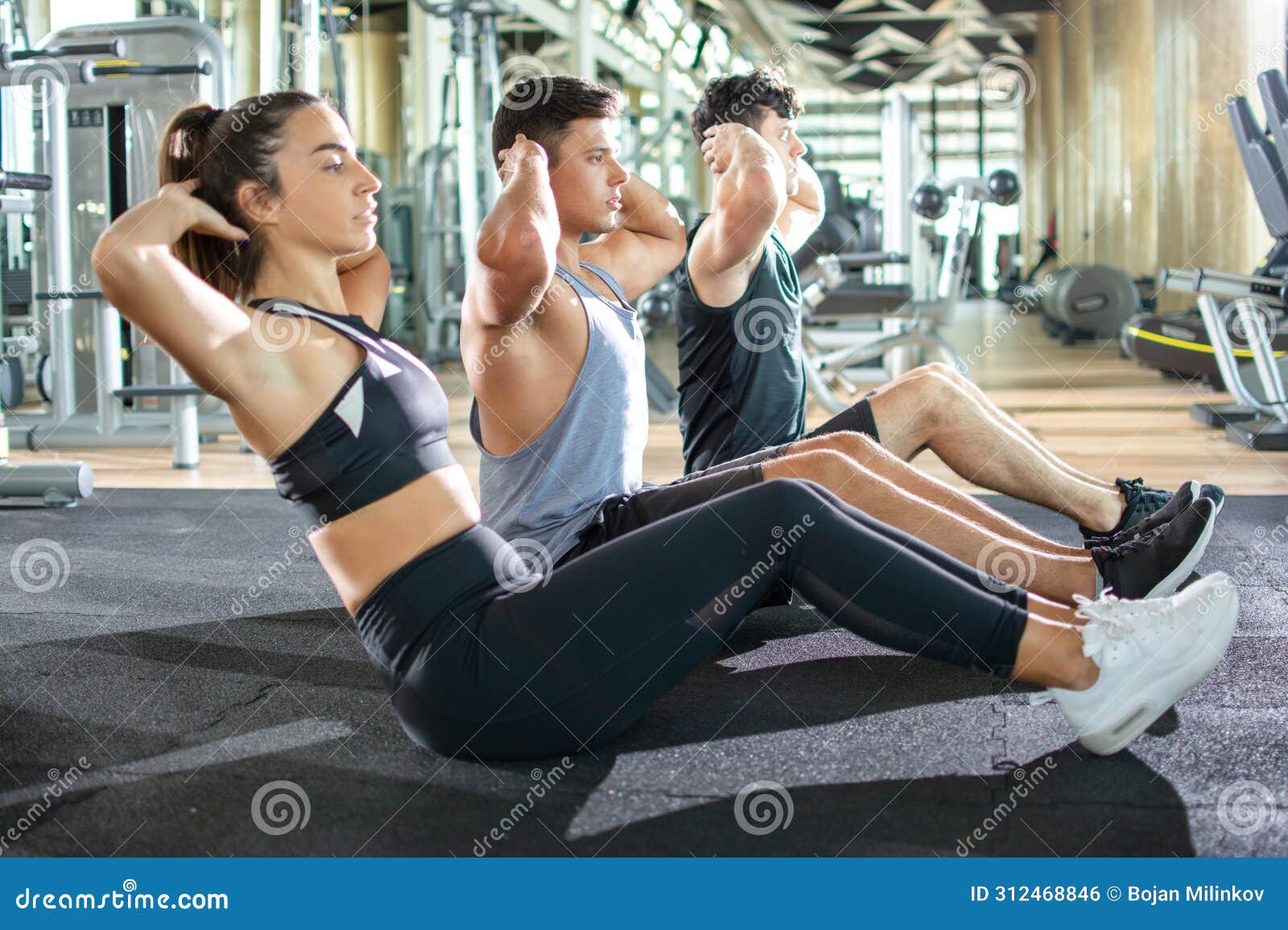 Group of Young Sporty People Doing Crunches at Gym. Stock Photo - Image ...