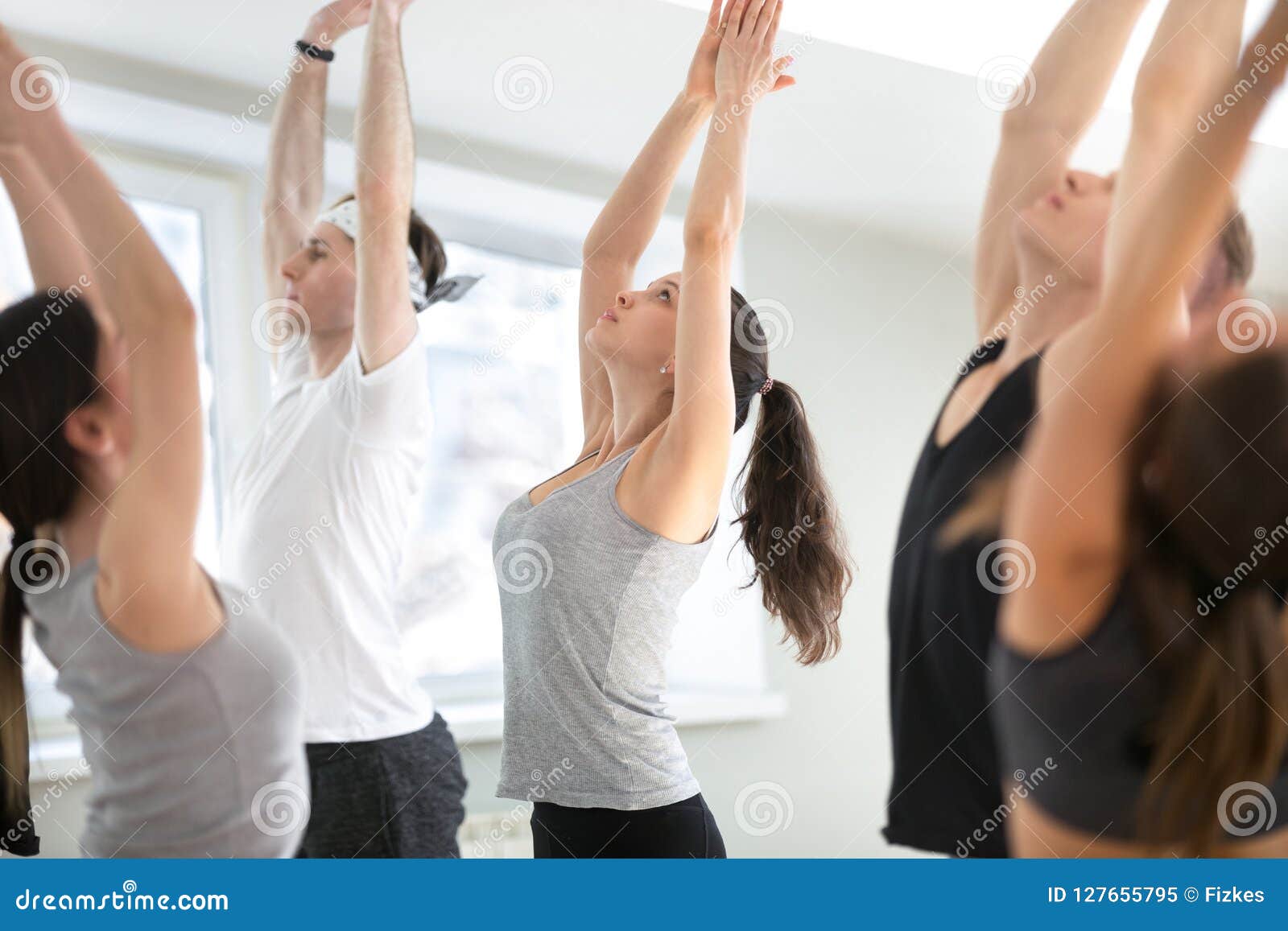 Group of Young Sporty People Practicing Yoga Lesson, Mountain Po Stock ... Group of Young Sporty People Practicing Yoga Lesson, Mountain Po Stock ...