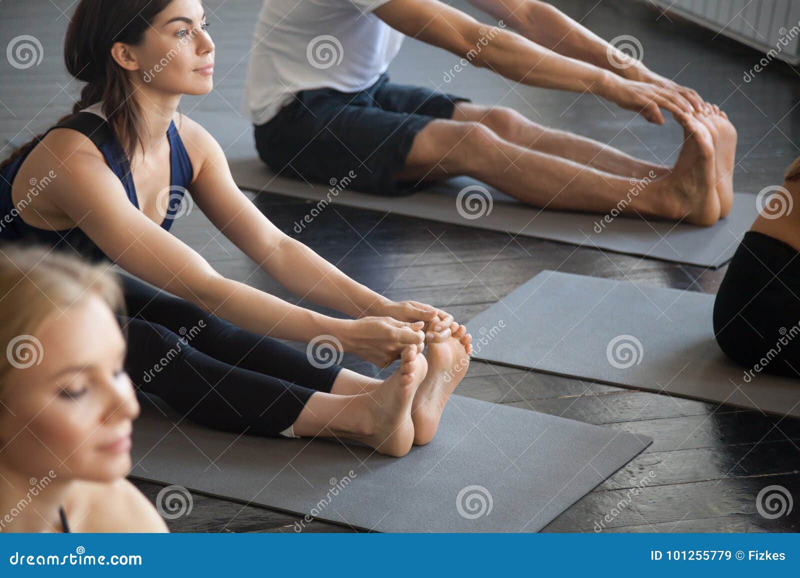 Group of Young Sporty People in Seated Forward Bend Exercise Stock ...