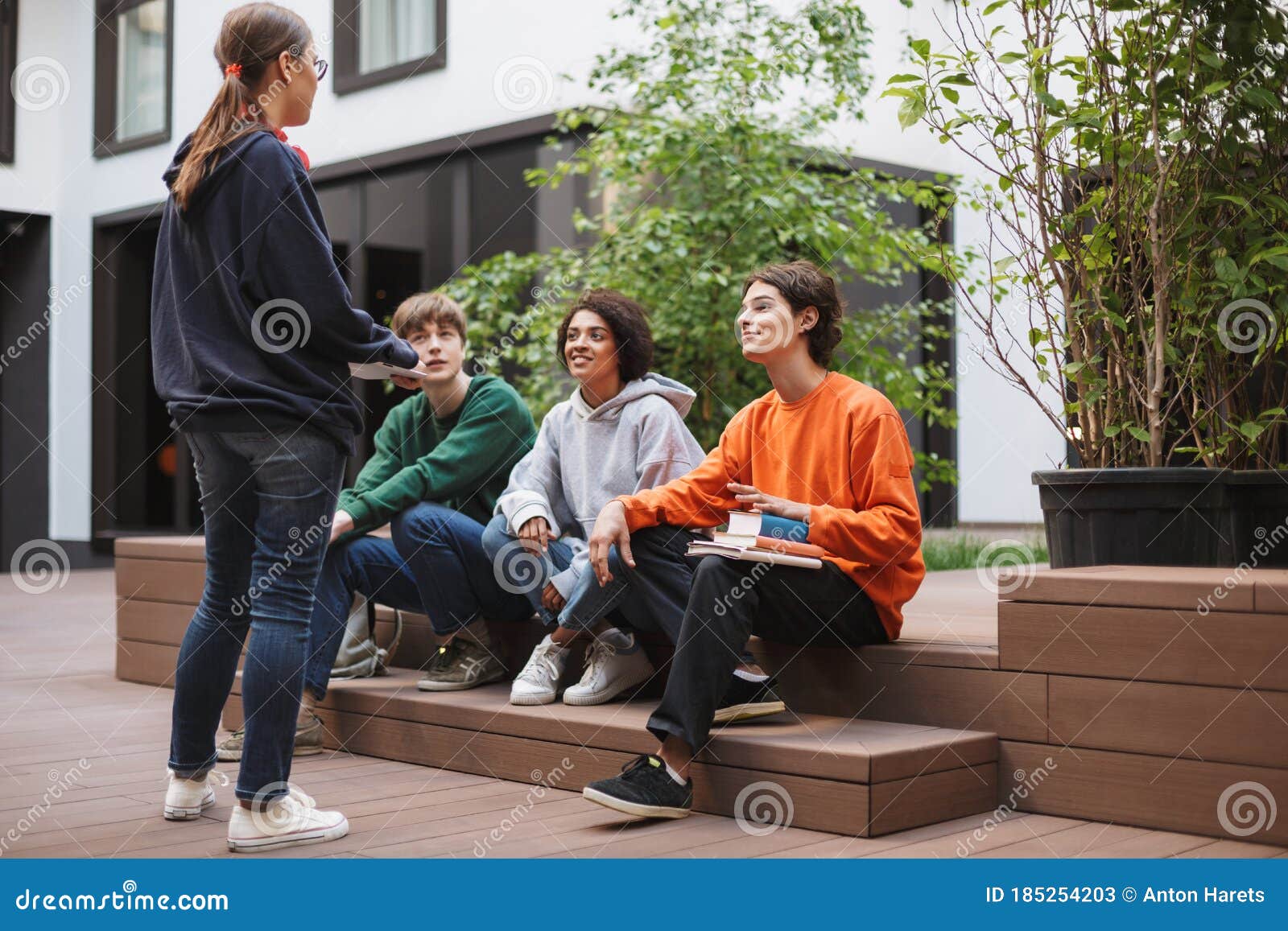 Group of Young Students Sitting and Preparing for Lesson while Studying ...