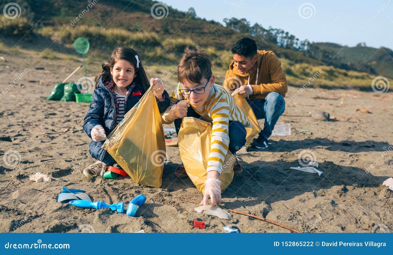 Young Volunteers Cleaning the Beach Stock Photo - Image of happy ...