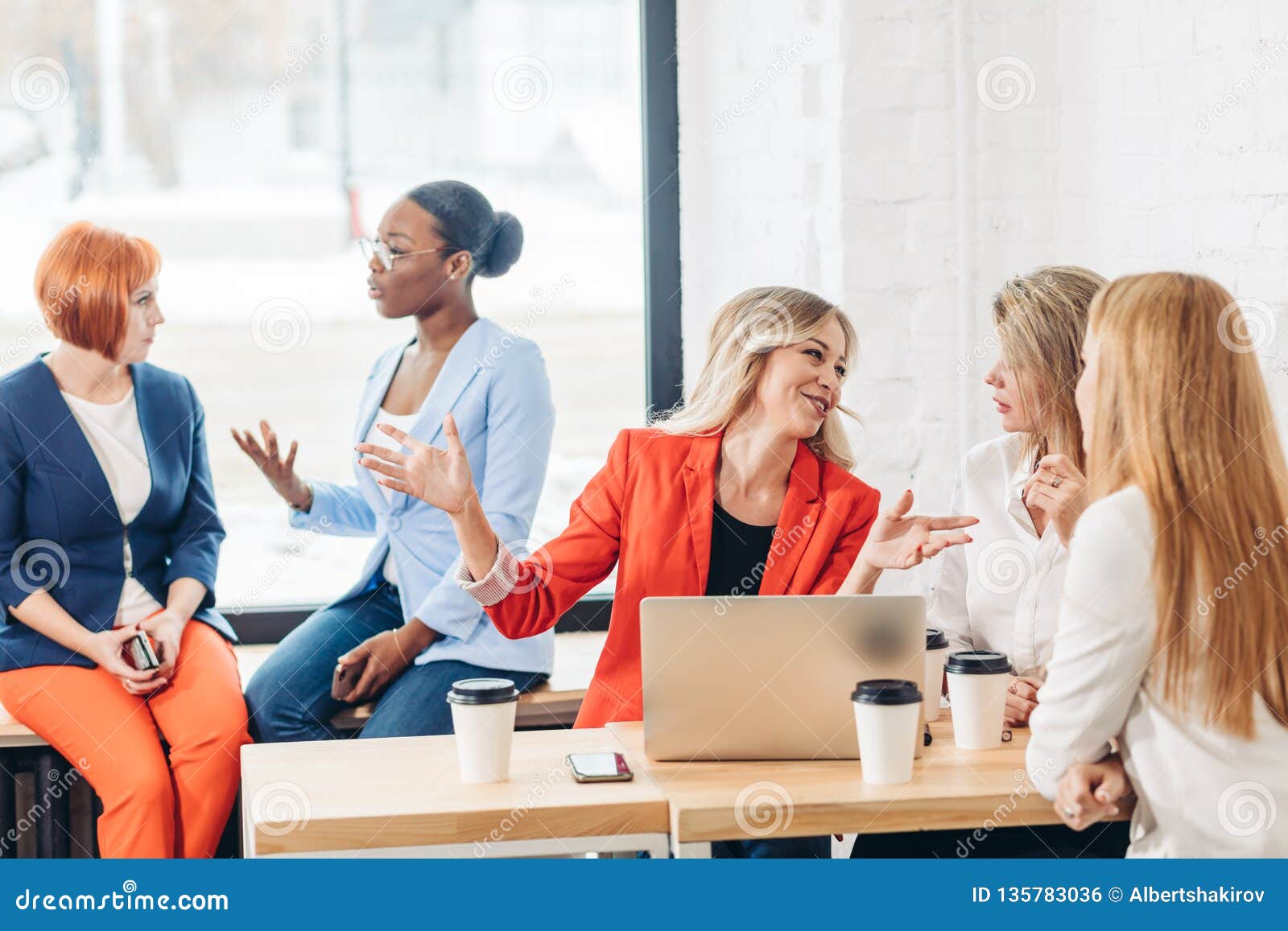 Group of Young Women Discussing Creative Project during Work Process ...