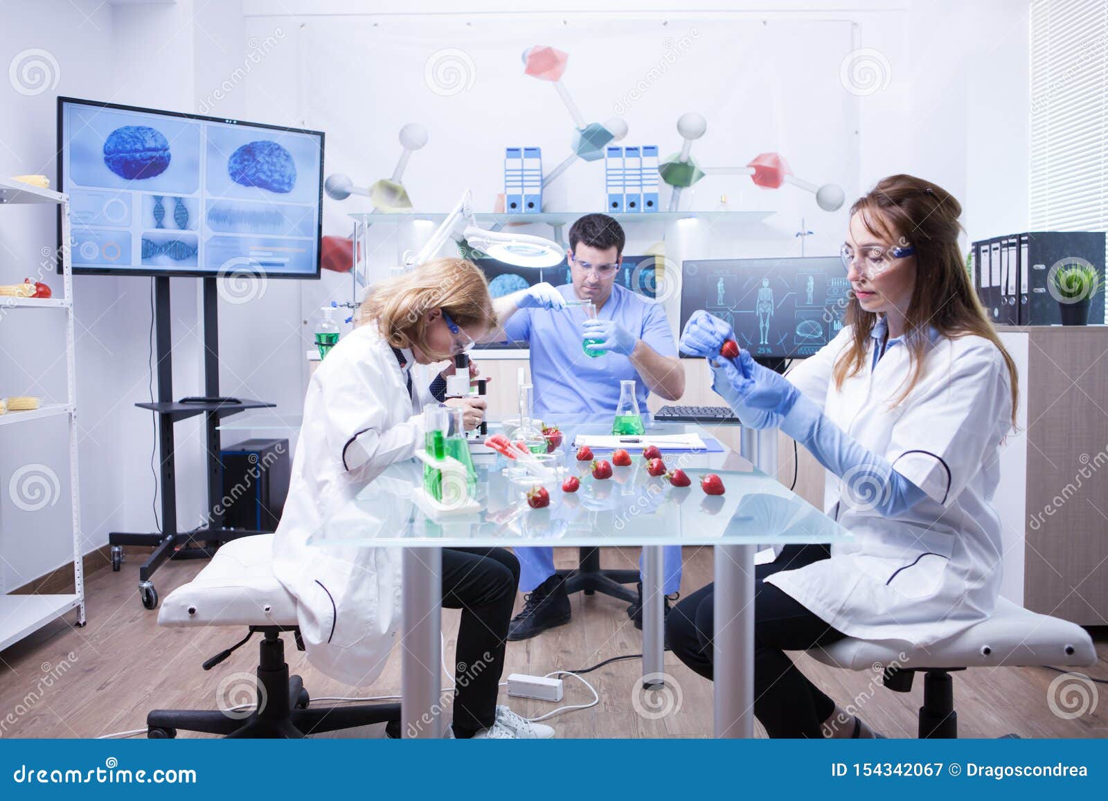 Groupe of Three Scientist Working in a Research Lab for Product ...