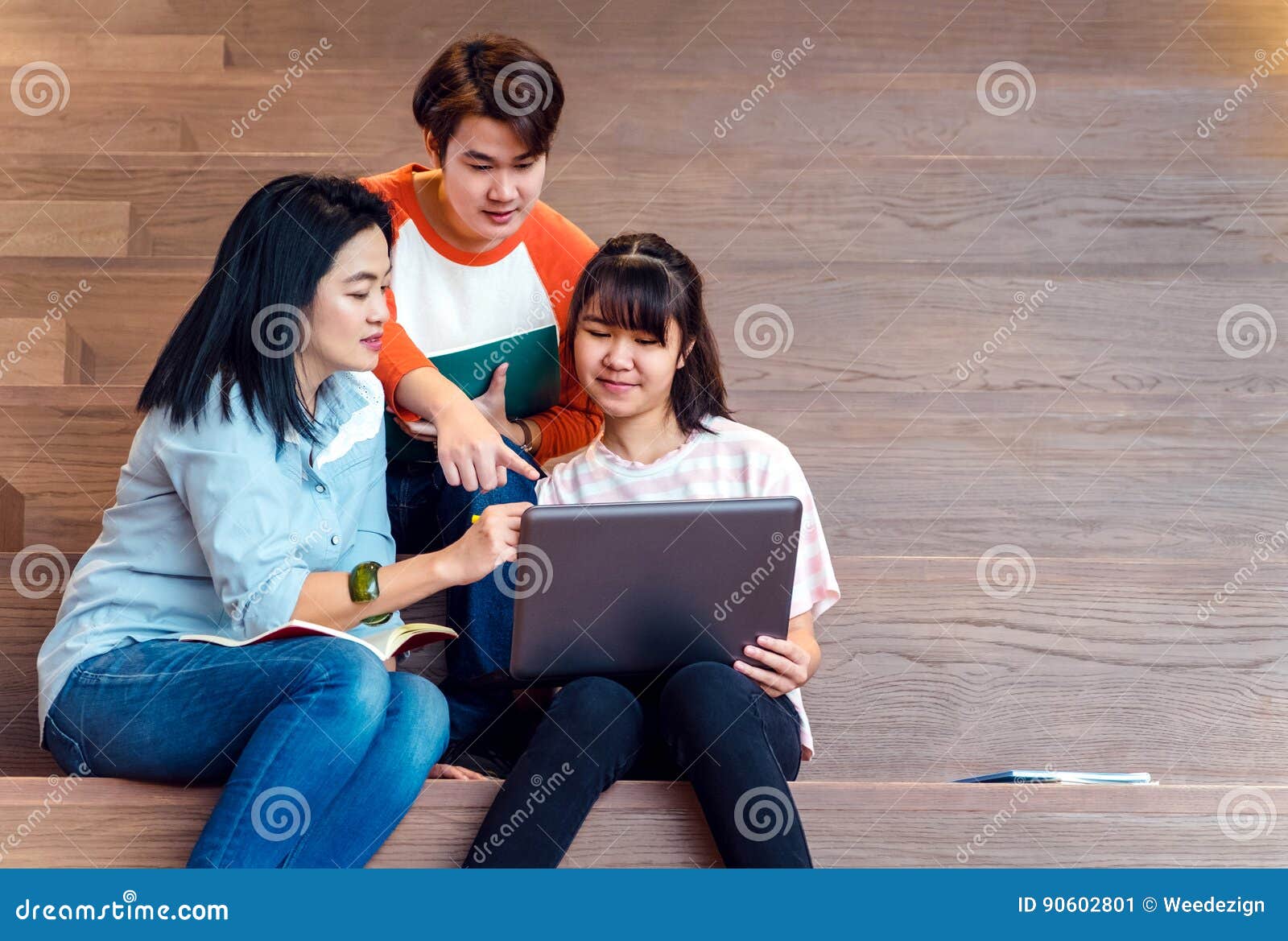 Groups of Asian Teenage Students Using Laptop Computer Studying Stock ...