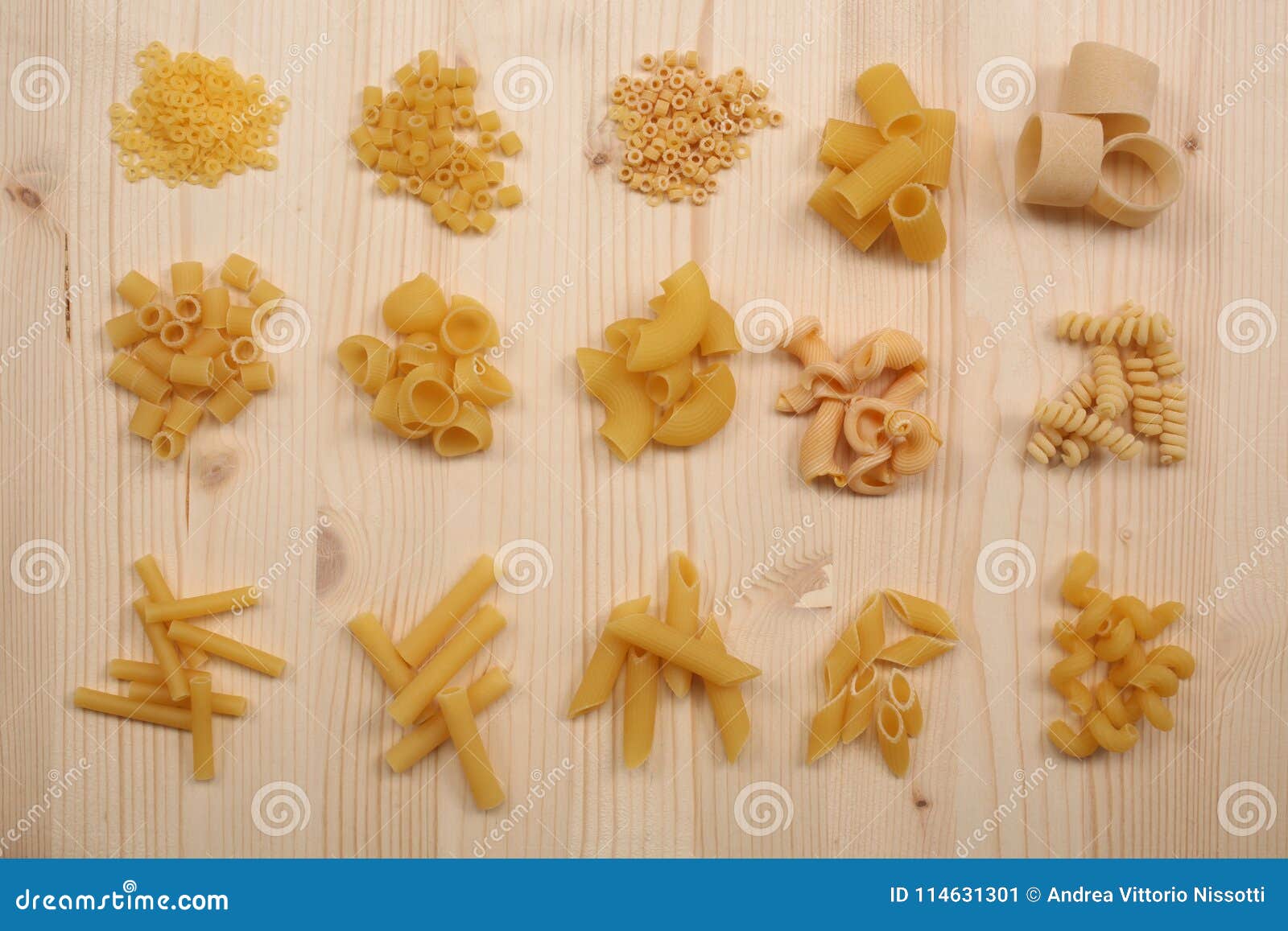 Groups of Different Kinds of Dry Uncooked Pasta on a Wooden Table Stock ...