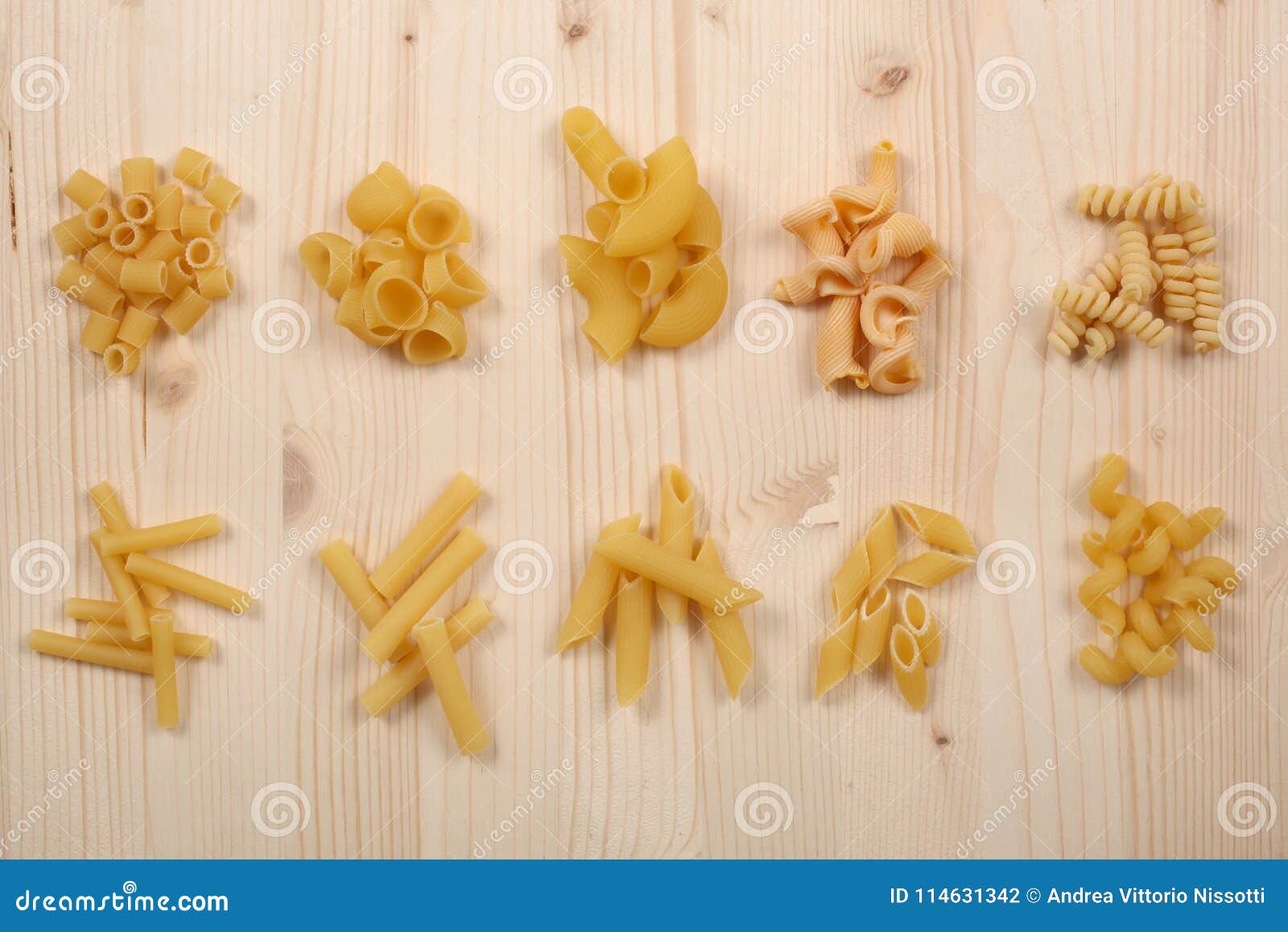 Groups of Different Kinds of Dry Uncooked Pasta on a Wooden Table Stock ...