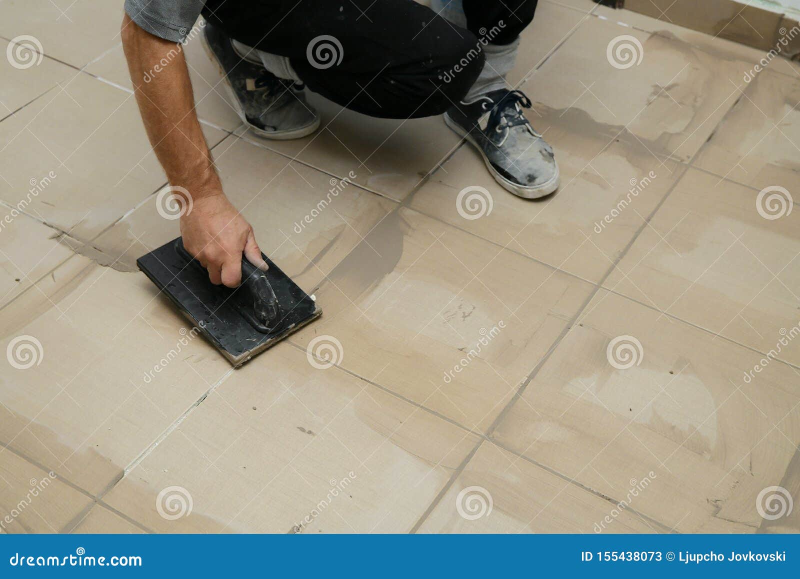 Grouting Ceramic Tiles, Close Up. Putting Fugue on Tiles on the Floor ...