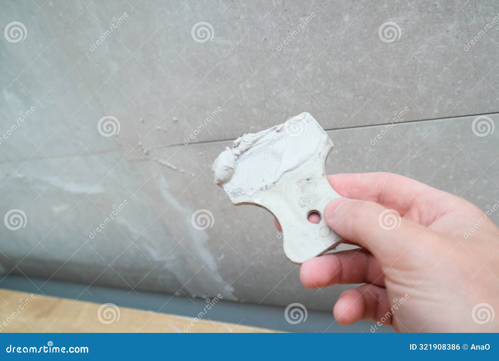 Grouting Ceramic Tiles Using a Fugue. Worker Putting Fugue on Tiles ... Grouting Ceramic Tiles Using a Fugue. Worker Putting Fugue on Tiles ...