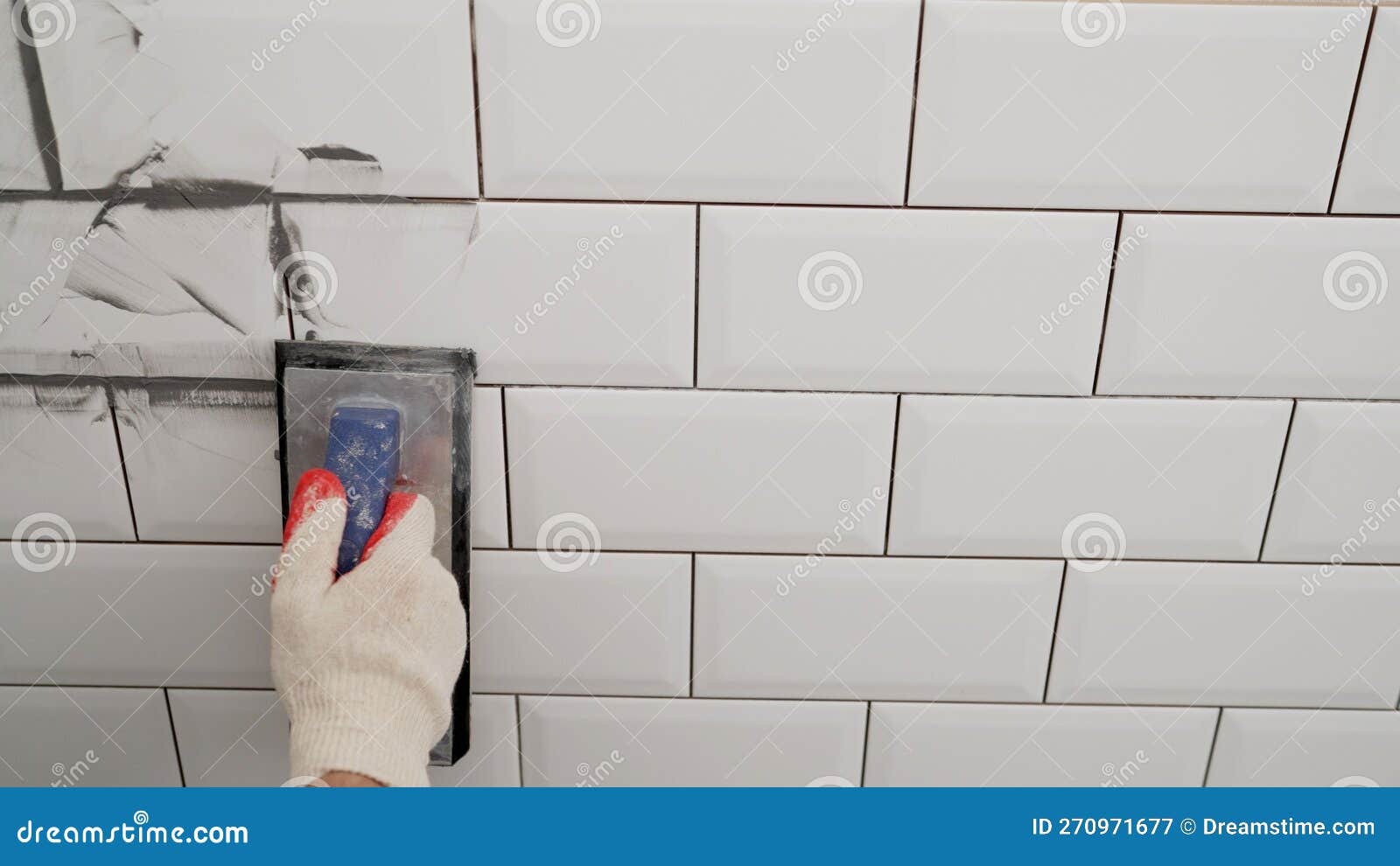 Workers Hands Using a Rubber Spatula and Grouting with Paste between ...