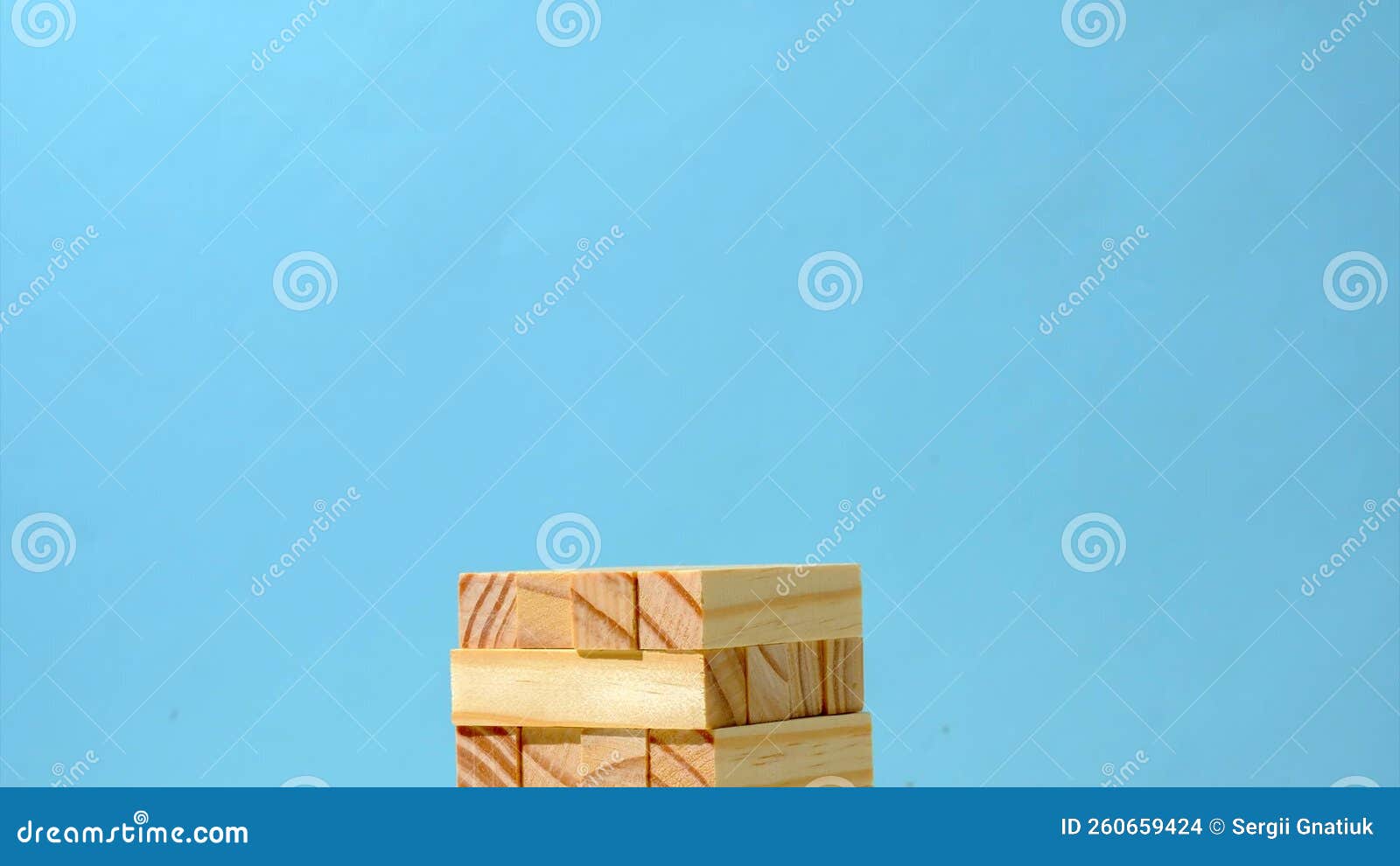Growing Tower Stack of Board Game Jenga on a Blue Background Stock ...