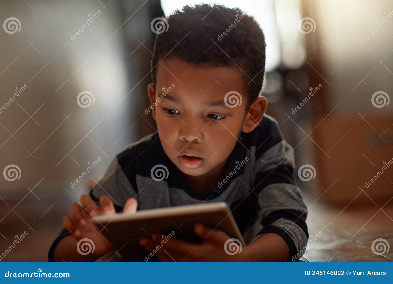 Growing Up with Technology. Shot of a Young Boy Using His Digital ...
