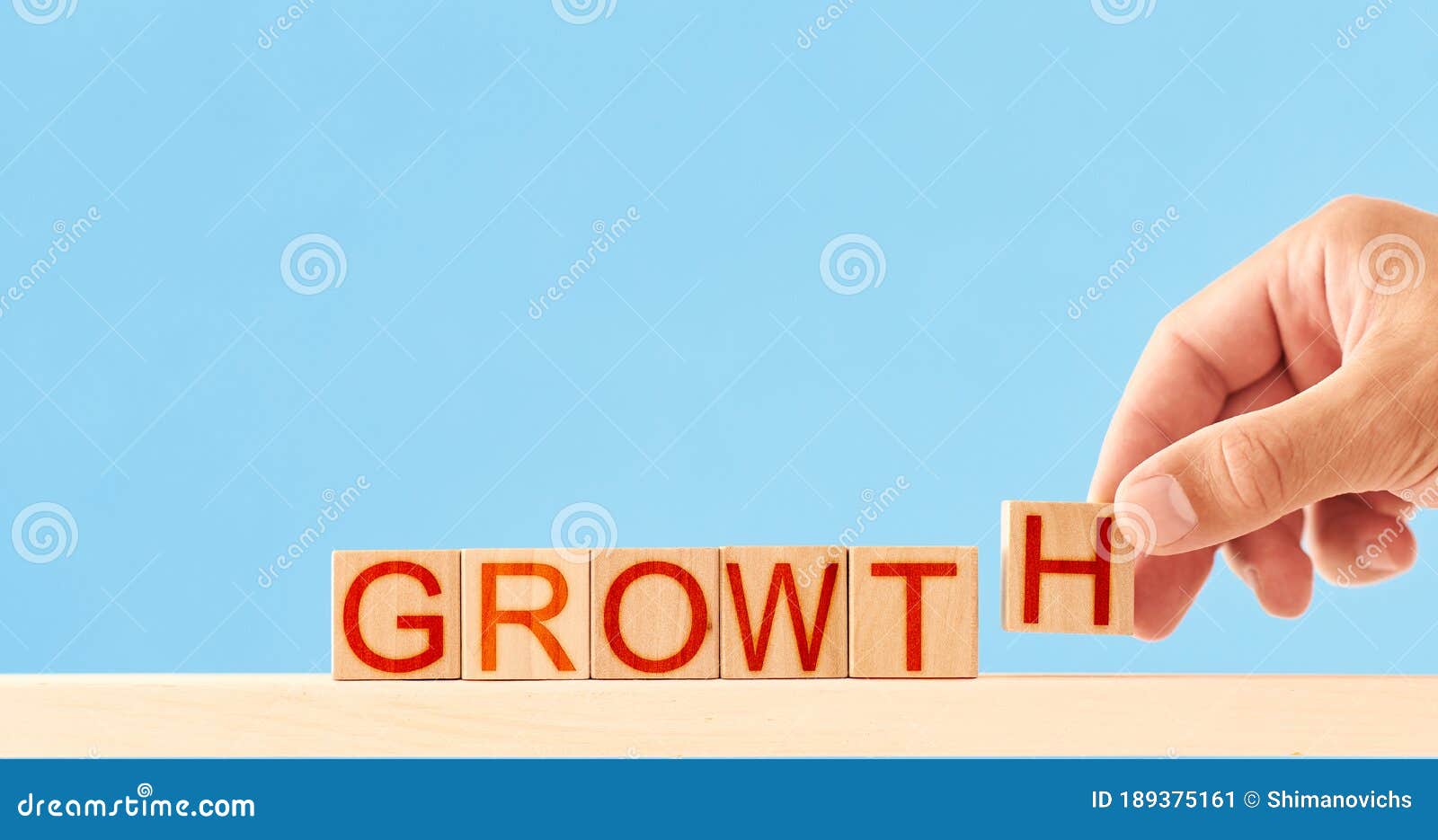 Growth Concept. Man Stacks Wooden Blocks Labeled Growth. Royalty-Free ...