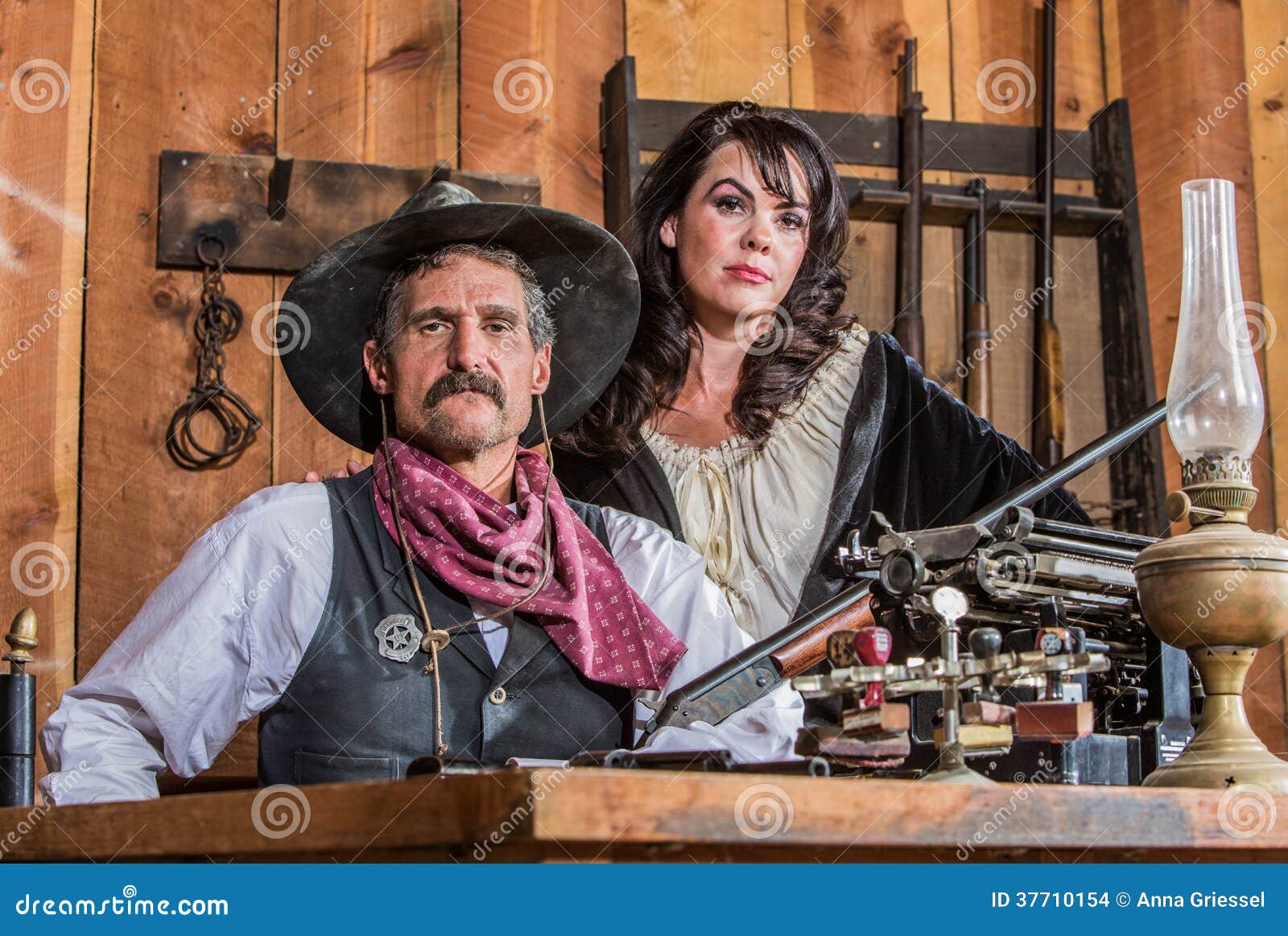 Gruff Cowboy Poses with Saloon Girl Stock Photo - Image of rifle ...