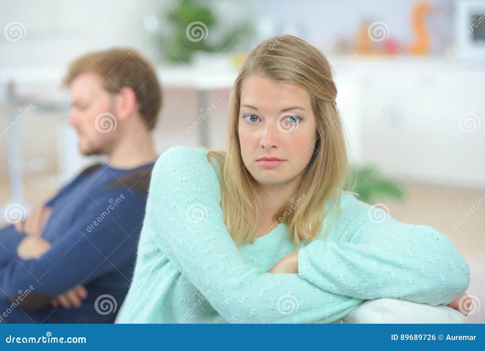 Grumpy couple sat on sofa stock photo. Image of crisis - 89689726