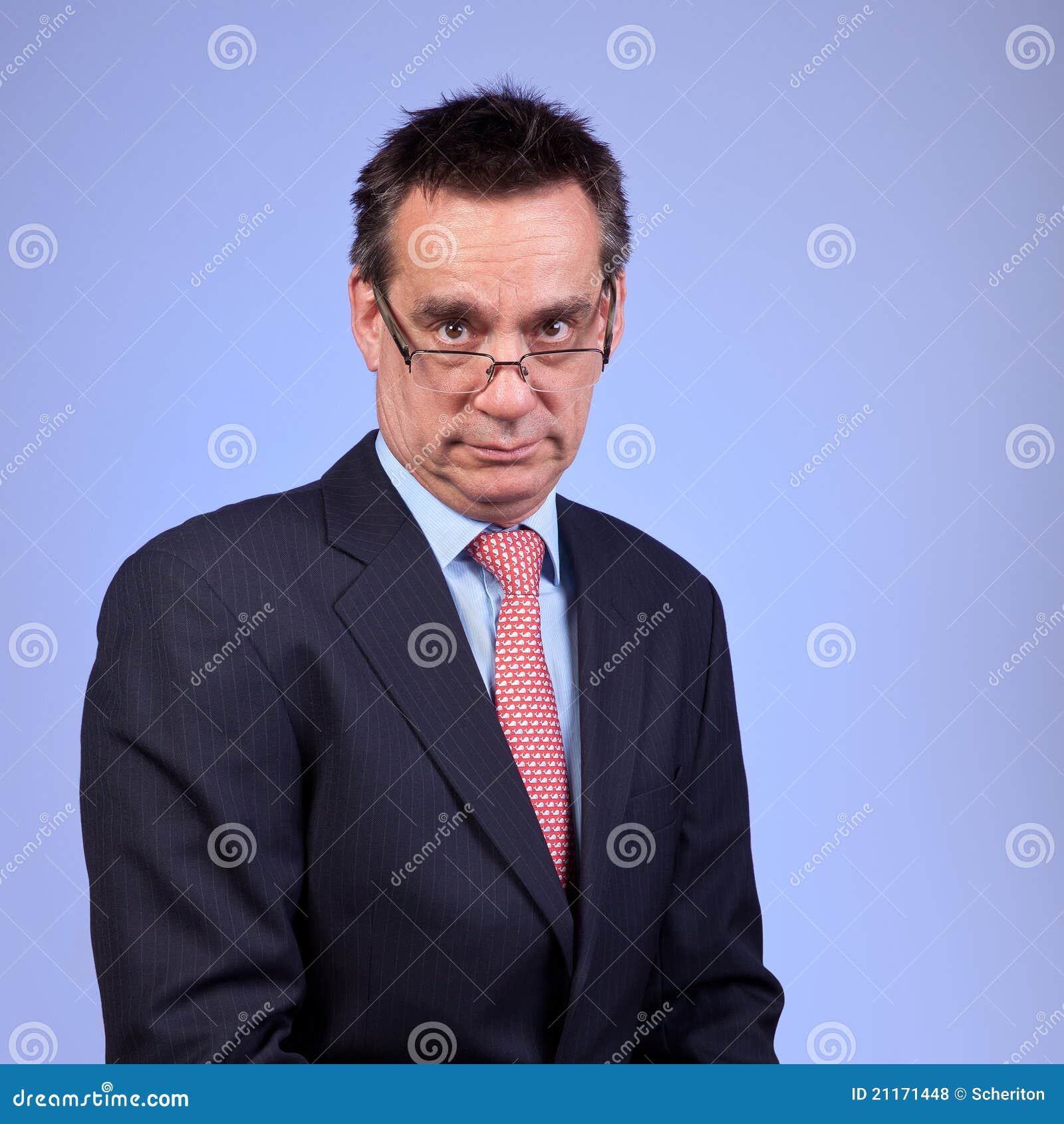 Frowning Grumpy Teen Boy Standing With Folded Arms Over Blue Background ... Frowning Grumpy Teen Boy Standing With Folded Arms Over Blue Background ...