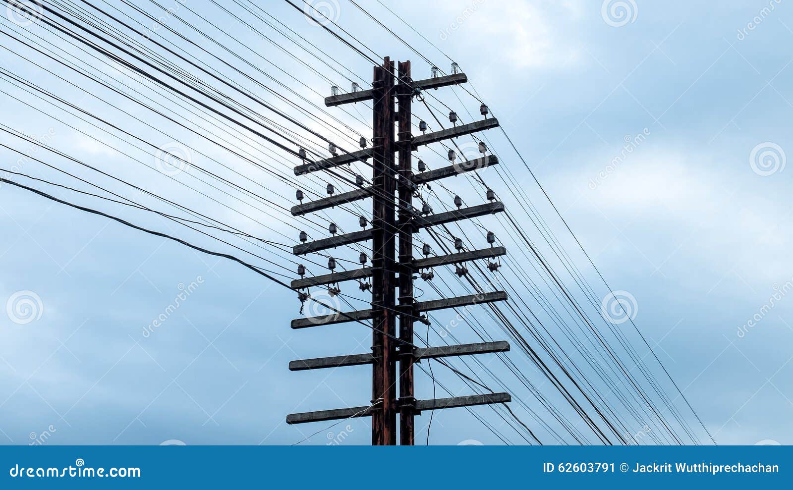 Grunge High Voltage Electrical Pole with a Lot of Cable Lines on Blue ...
