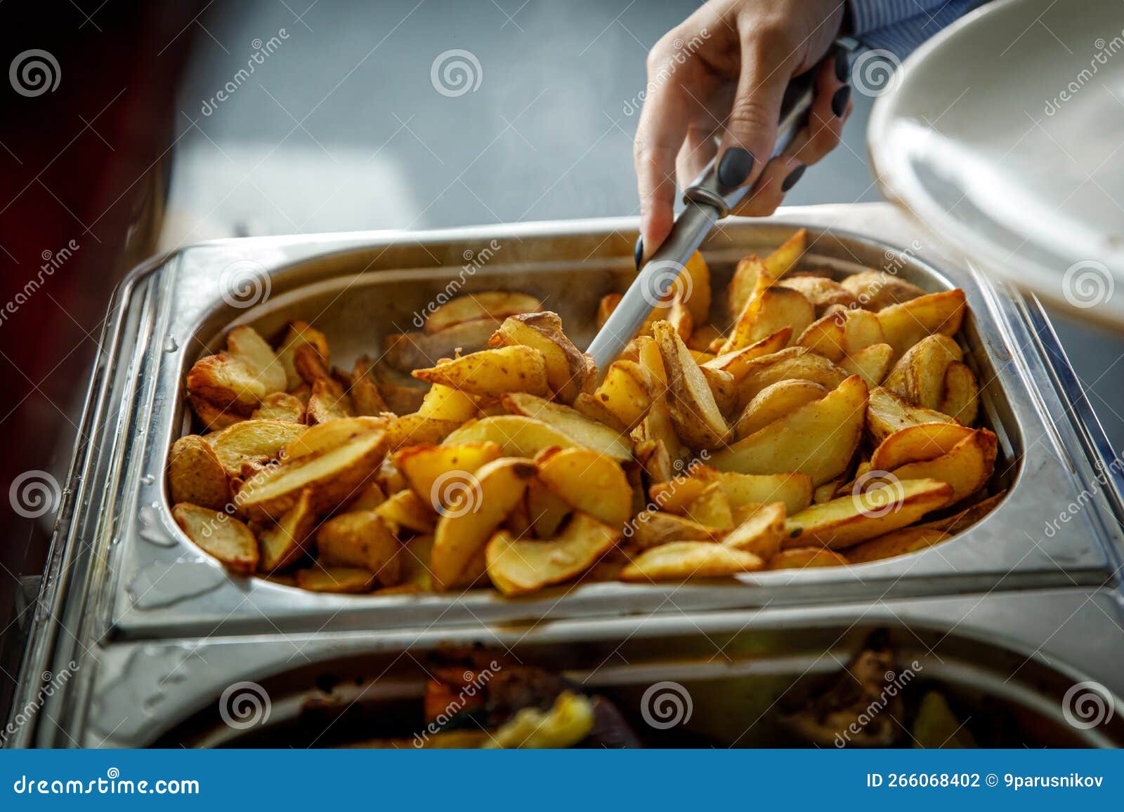 The Guest Puts Potatoes on His Plate. Buffet in the Hotel. Stock Photo ...