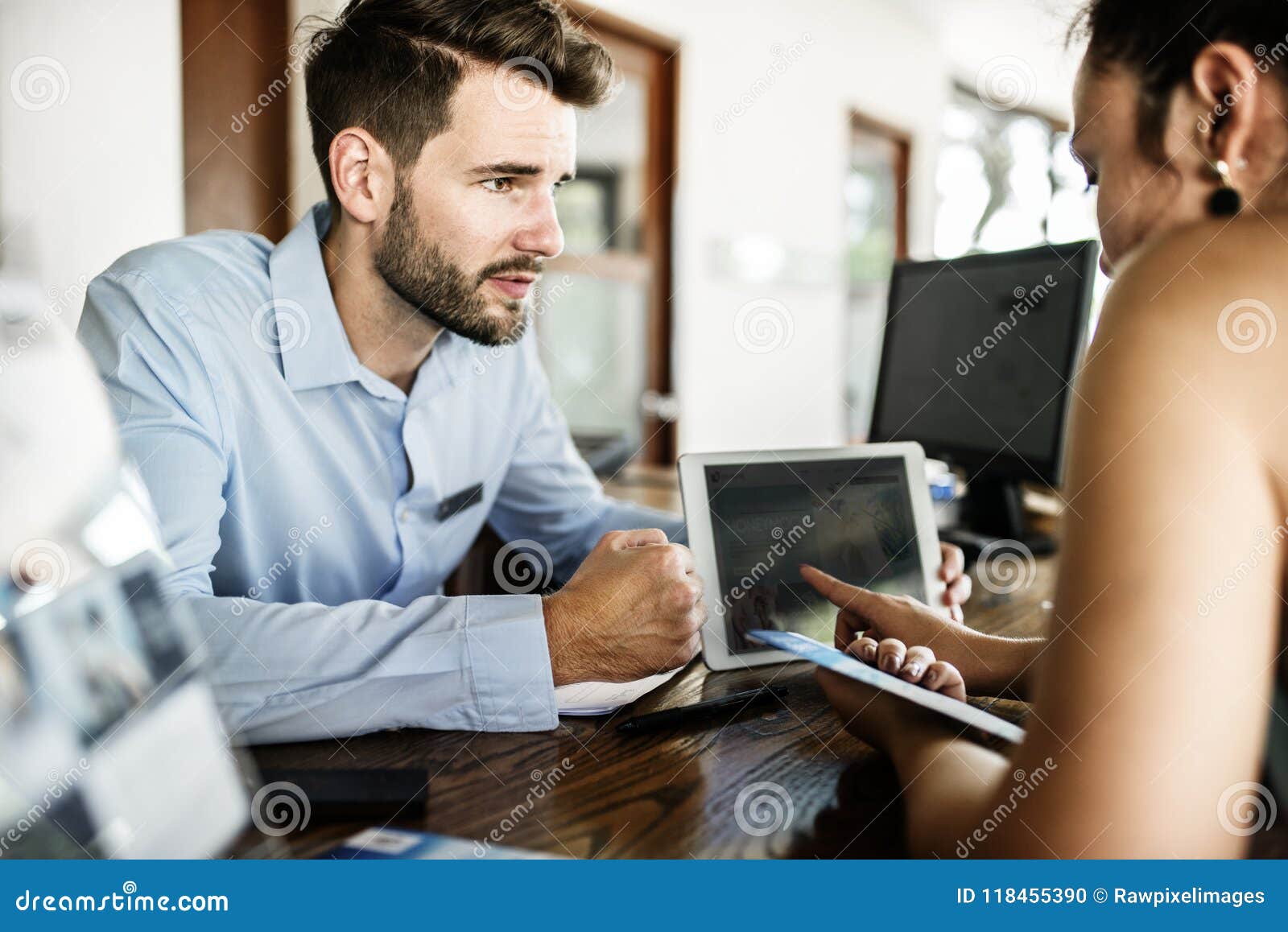 Guests Checking into a Hotel Stock Photo - Image of receptionist ...