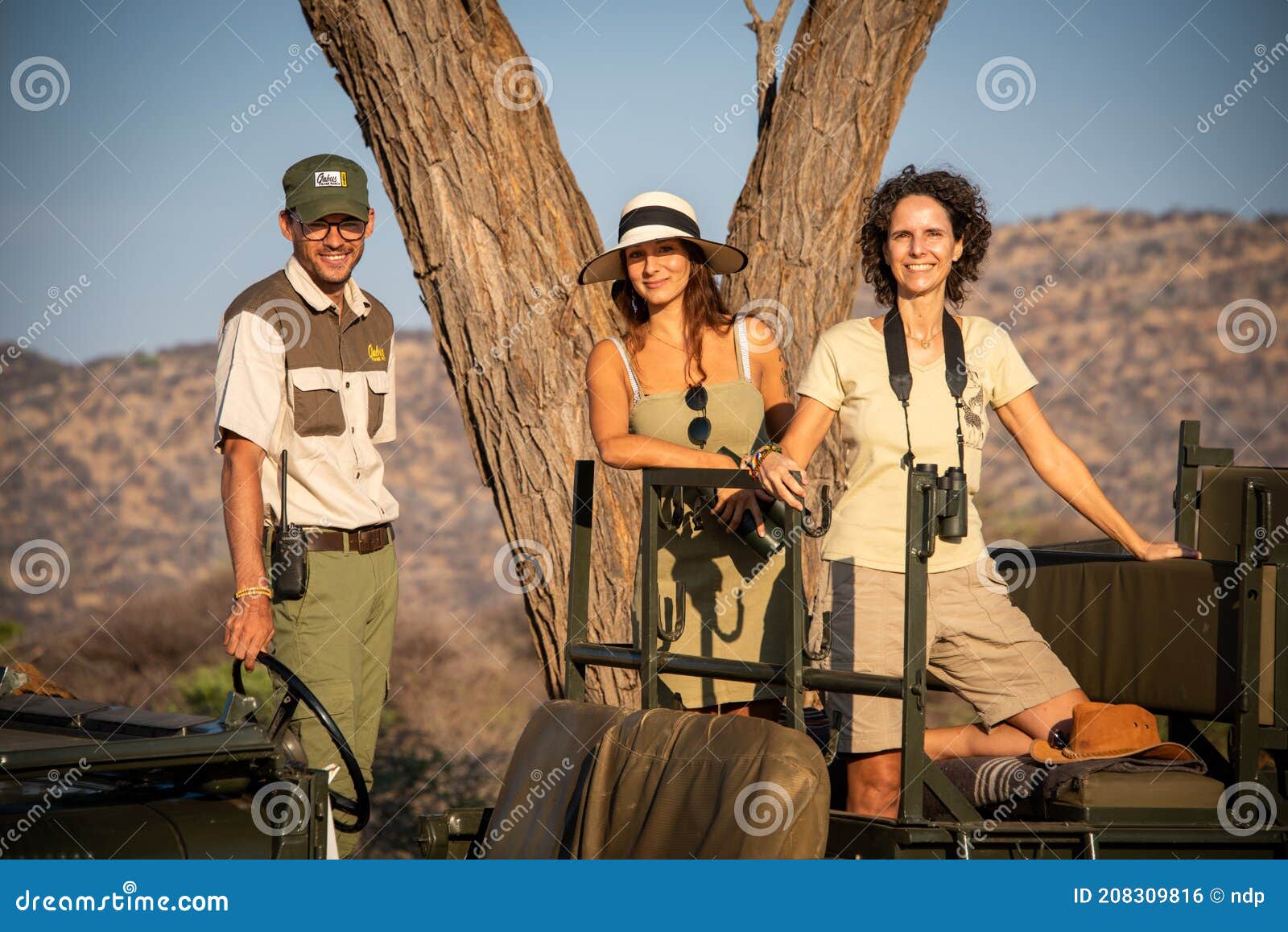 Guide and Two Brunettes Smiling in Jeep Stock Photo - Image of ...