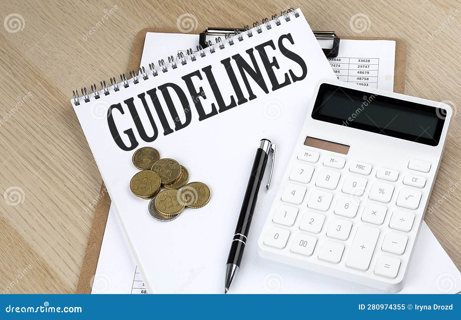 GUIDELINES Text on a Notebook with Chart and Calculator and Coins ...