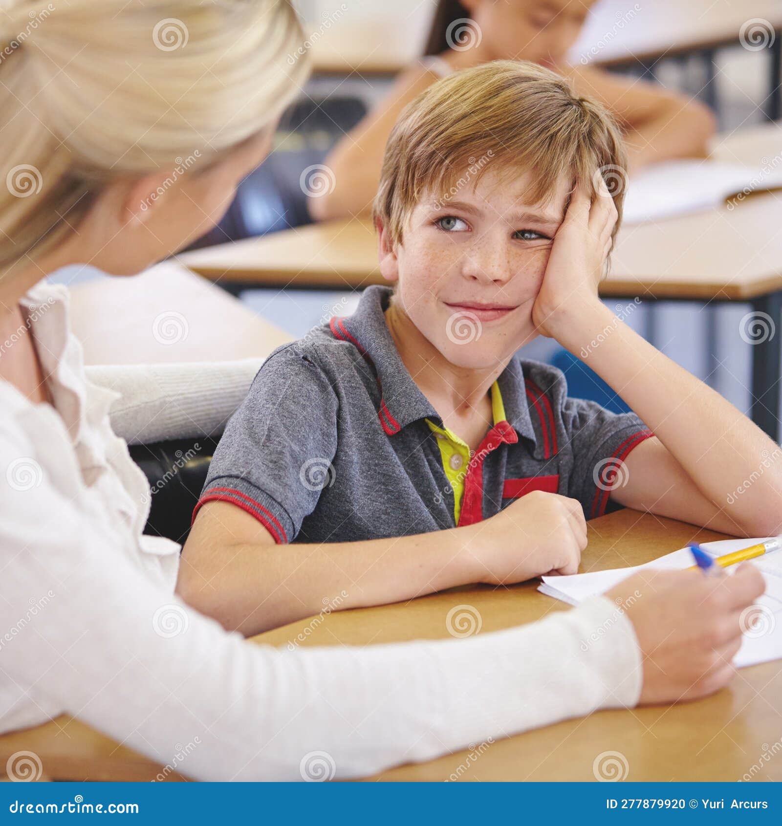Guiding and Inspiring. a Young Teacher Assisting a Student with ...