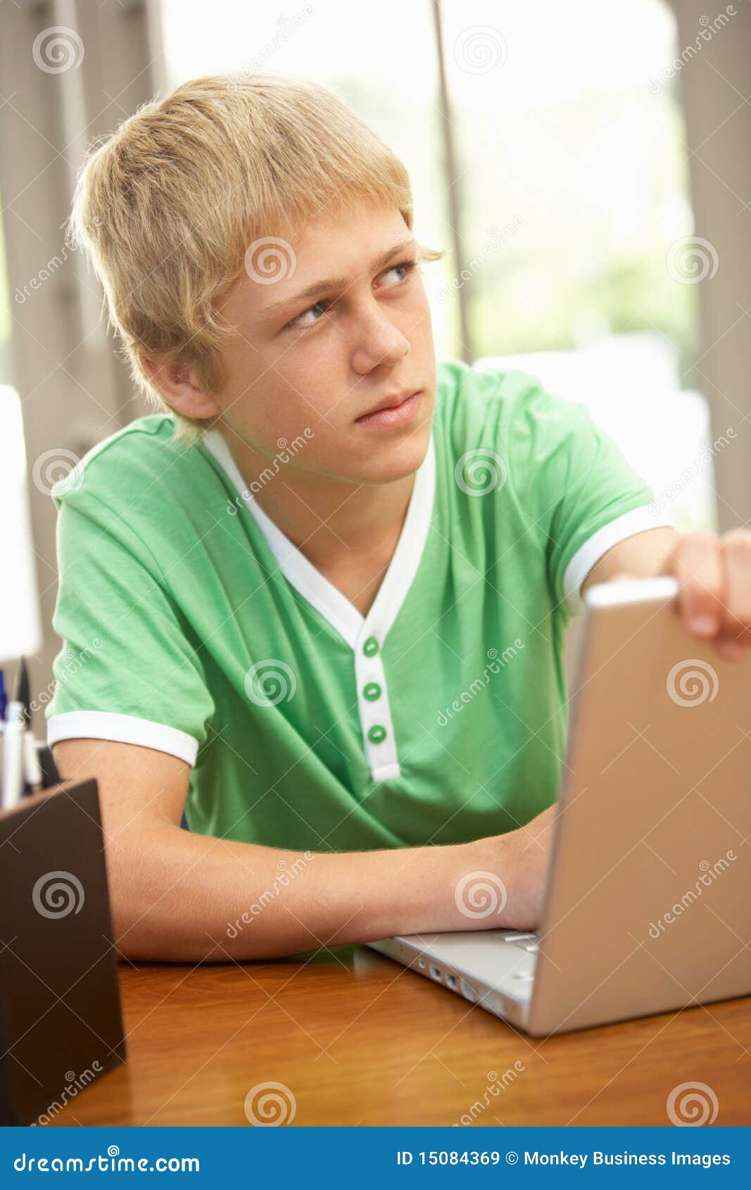 Guilty Looking Teenage Boy Using Laptop at Home Stock Image - Image of ...
