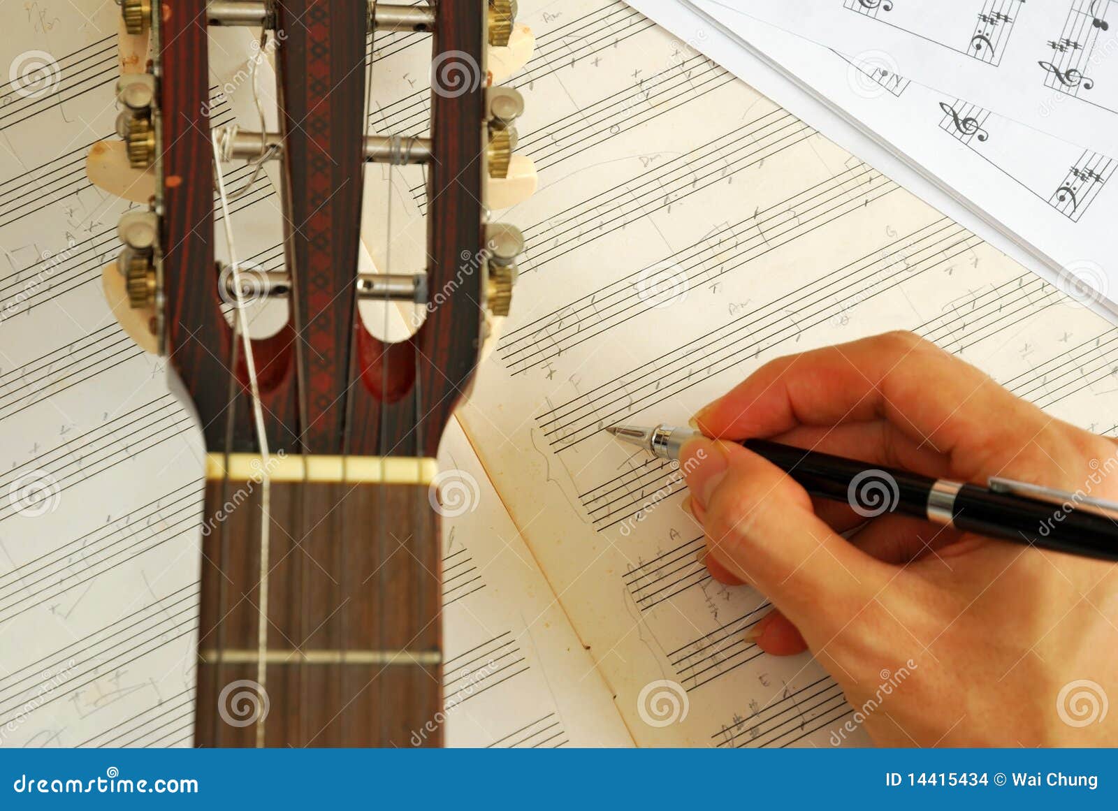 Guitar with Hand Composing Music on Manuscript Stock Photo - Image of ...