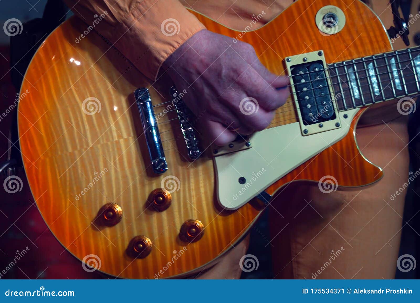 Guitar in the Hands of a Guitarist Standing on Stage in Spotlight Stock ...