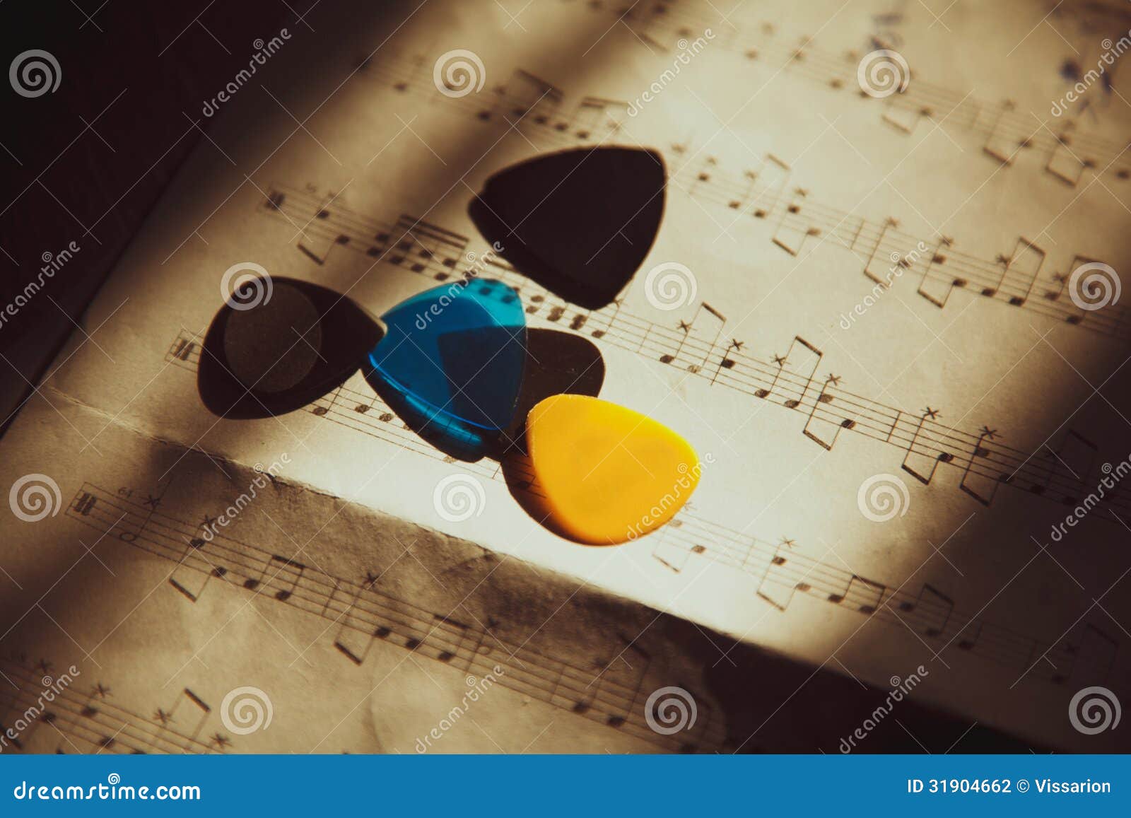 Guitar Picks on Misic Notes Stock Photo - Image of notation, plastic ...
