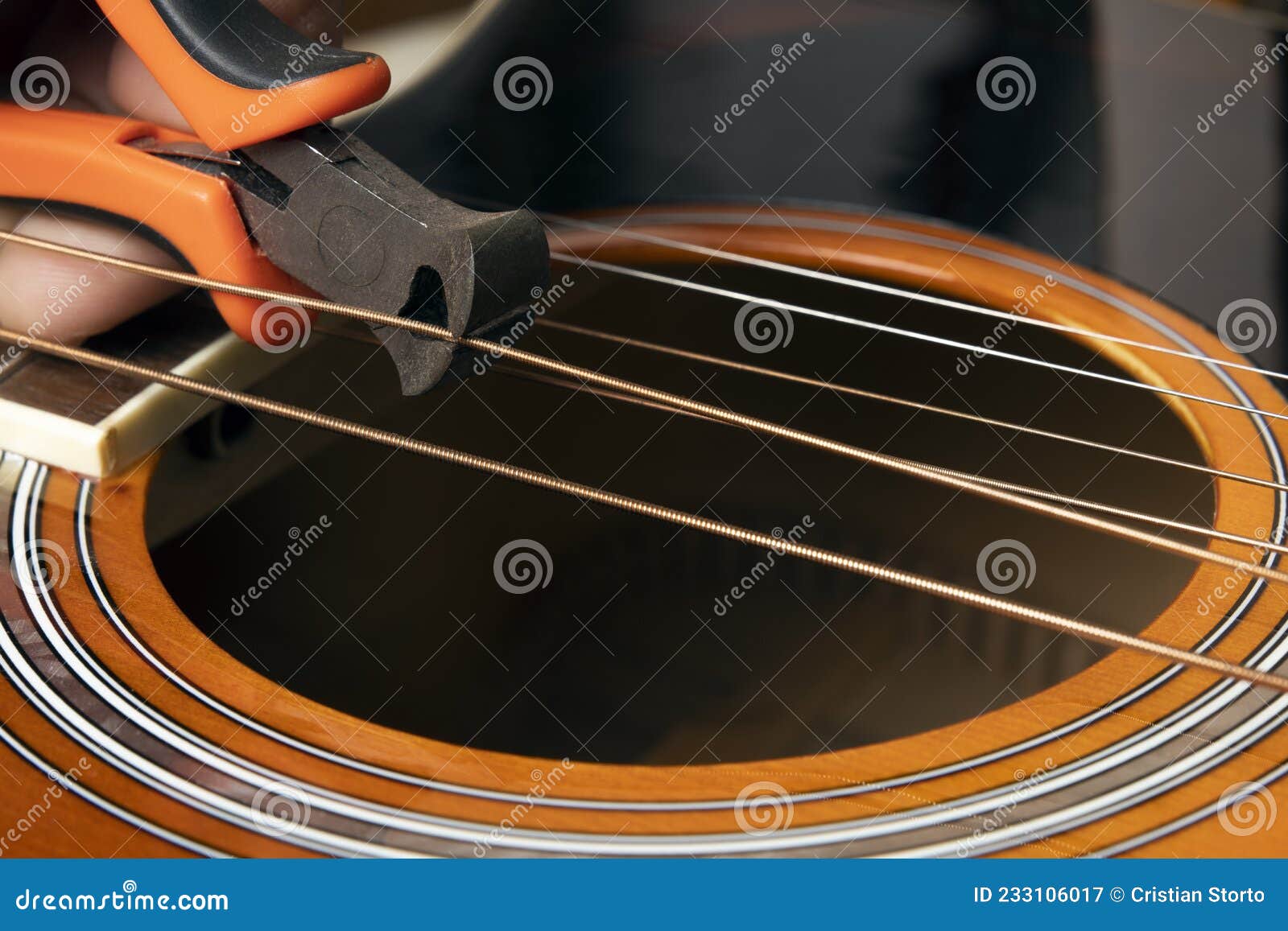 Guitar Restring: Musician Cut Strings from an Acoustic Guitar Stock ...