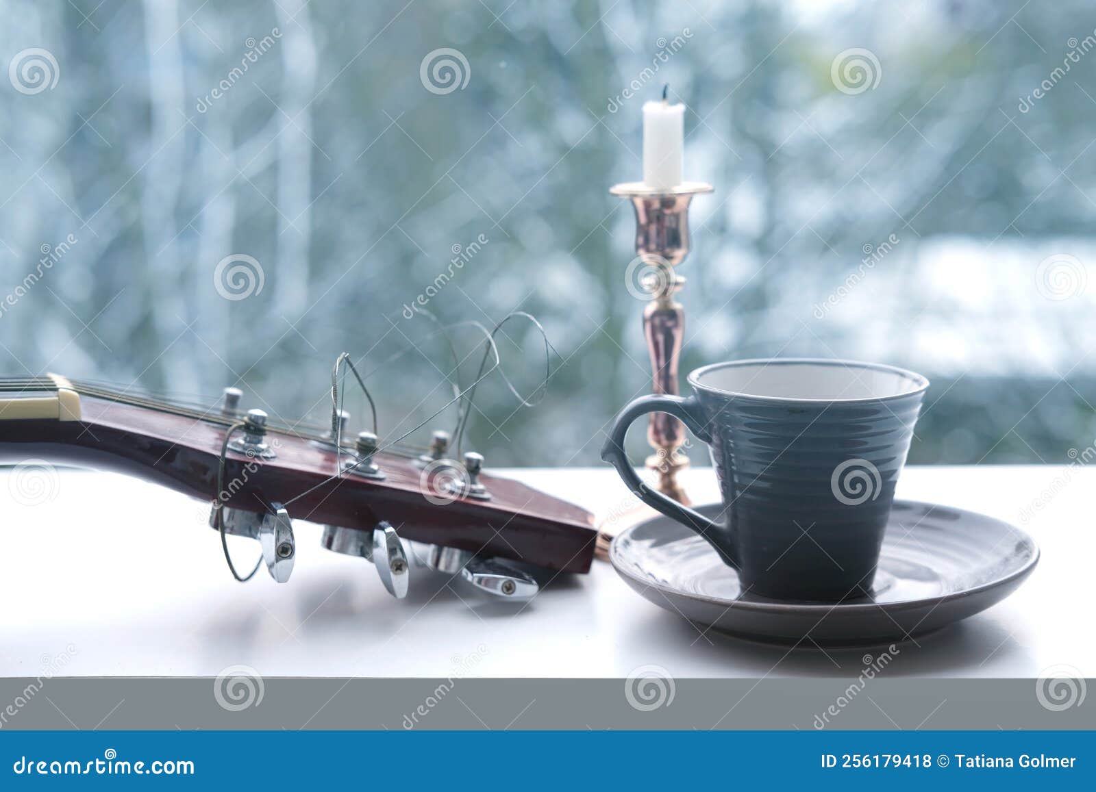 Guitar with Strings, a Cup of Coffee, Tea, a Candle in a Candlestick ...