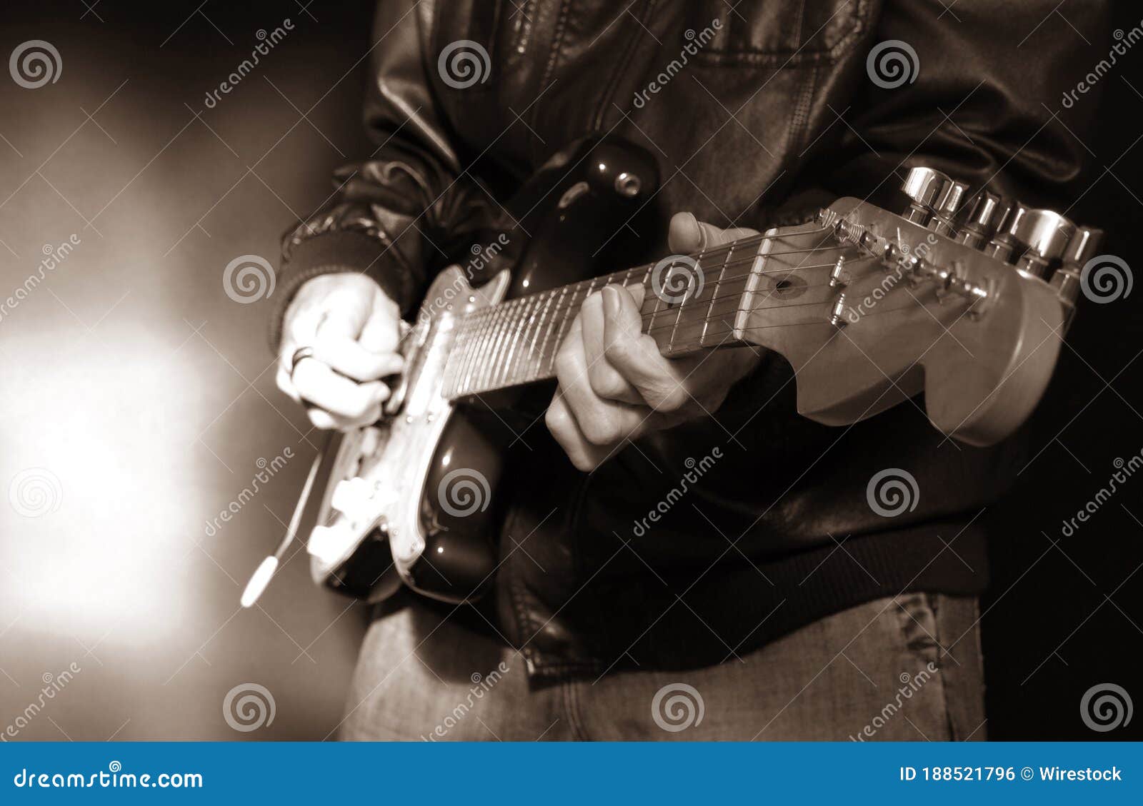 Guitarist Player in Leather Jacket Playing a 5 String Electric Guitar ...