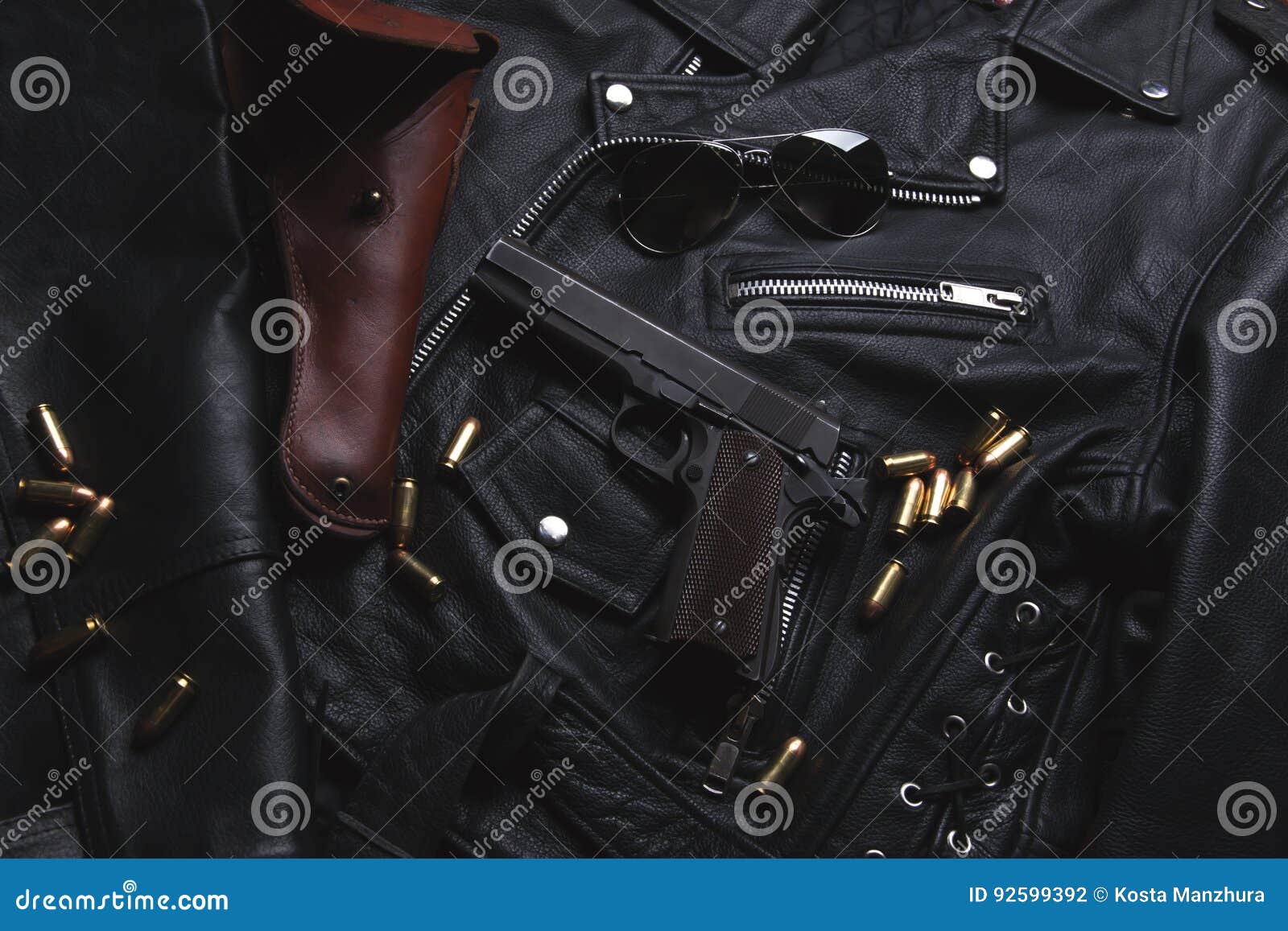 Gun Colt with Bullets and Holster Rests on a Leather Jacket Stock Photo ...