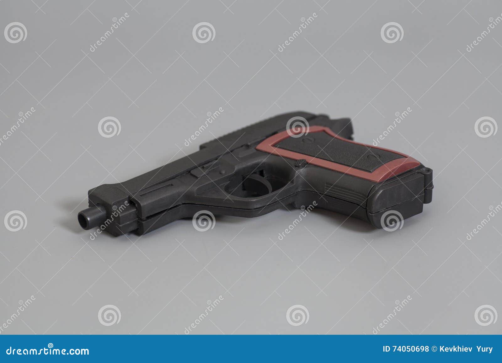 Gun on gray background stock photo. Image of murder, handgun - 74050698