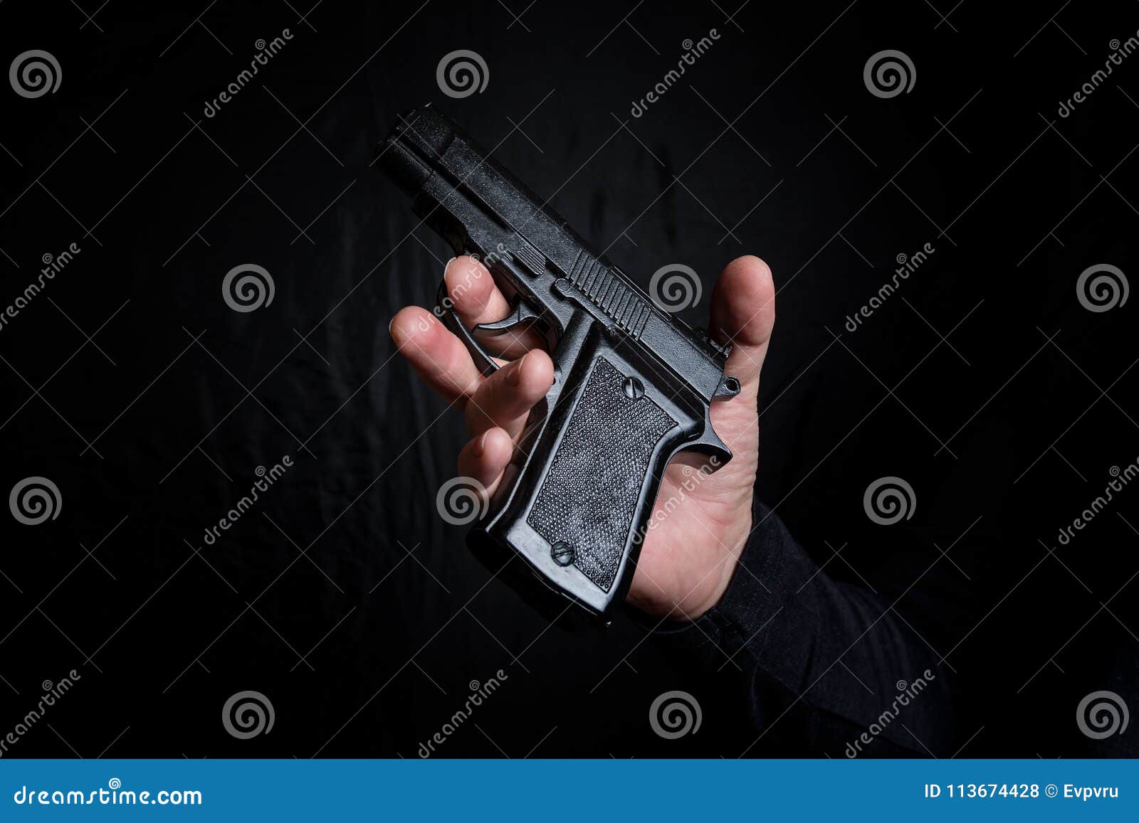 Gun in the hand of man stock photo. Image of profile - 113674428