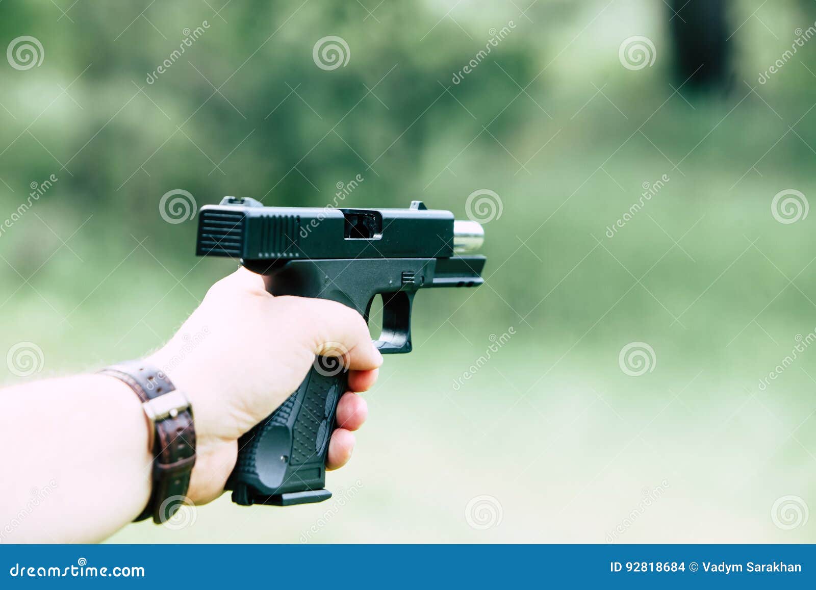 The Gun is in His Hand. the Man is Ready To Shoot at the Target. Stock ...