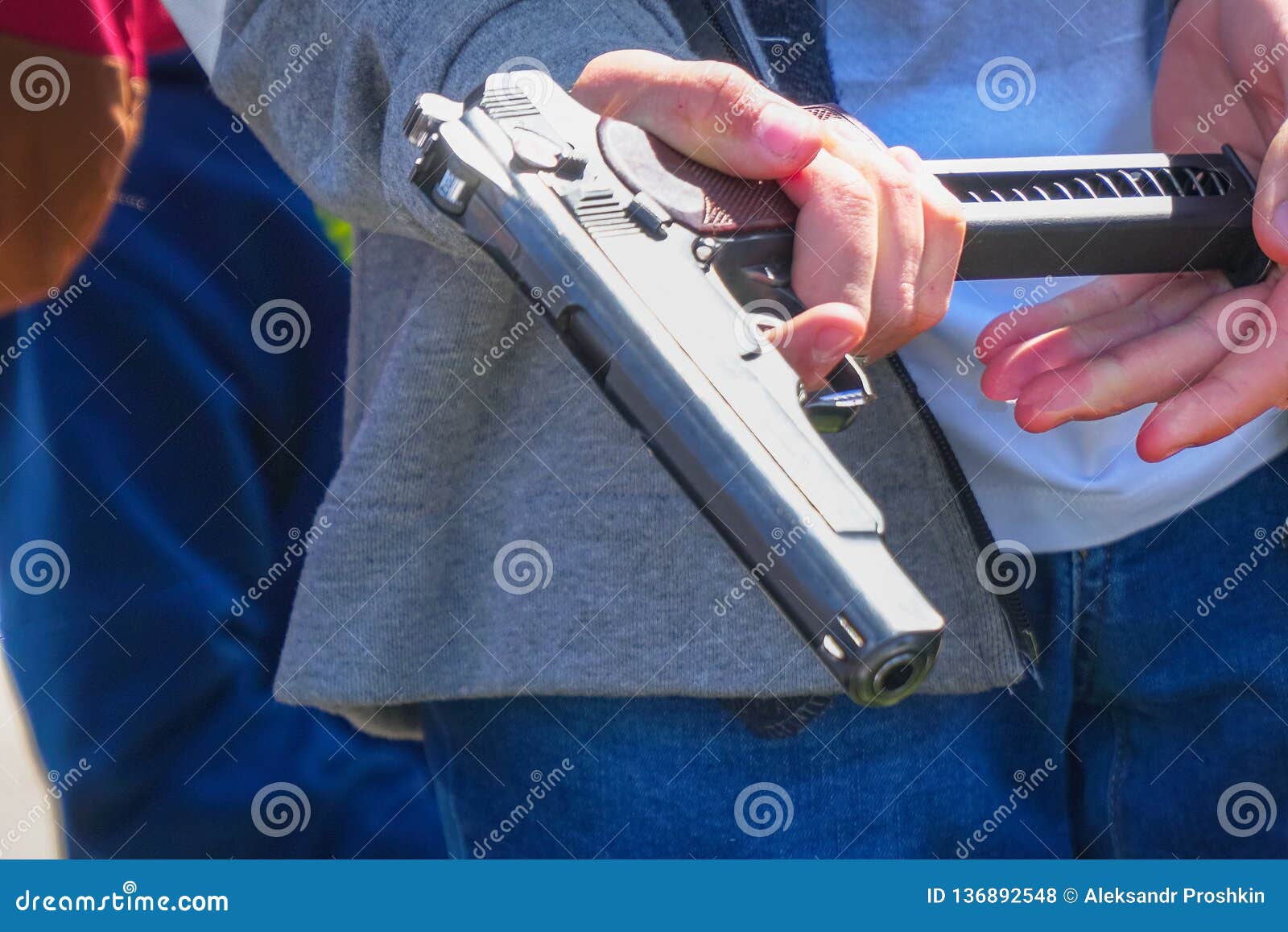 The gun in the man s hand stock photo. Image of outdoor - 136892548
